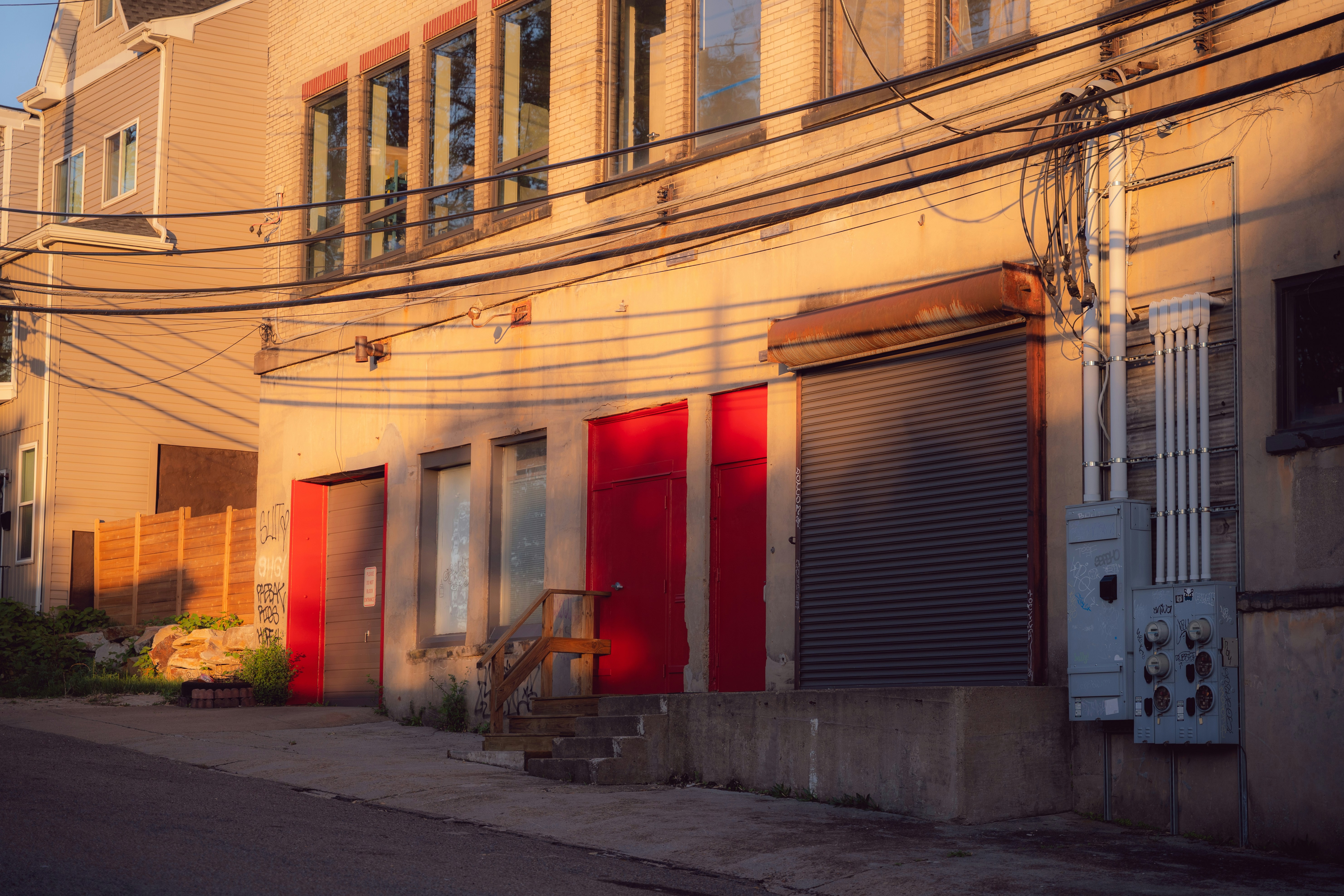 Sunlit Alley Facade with Red Doors
