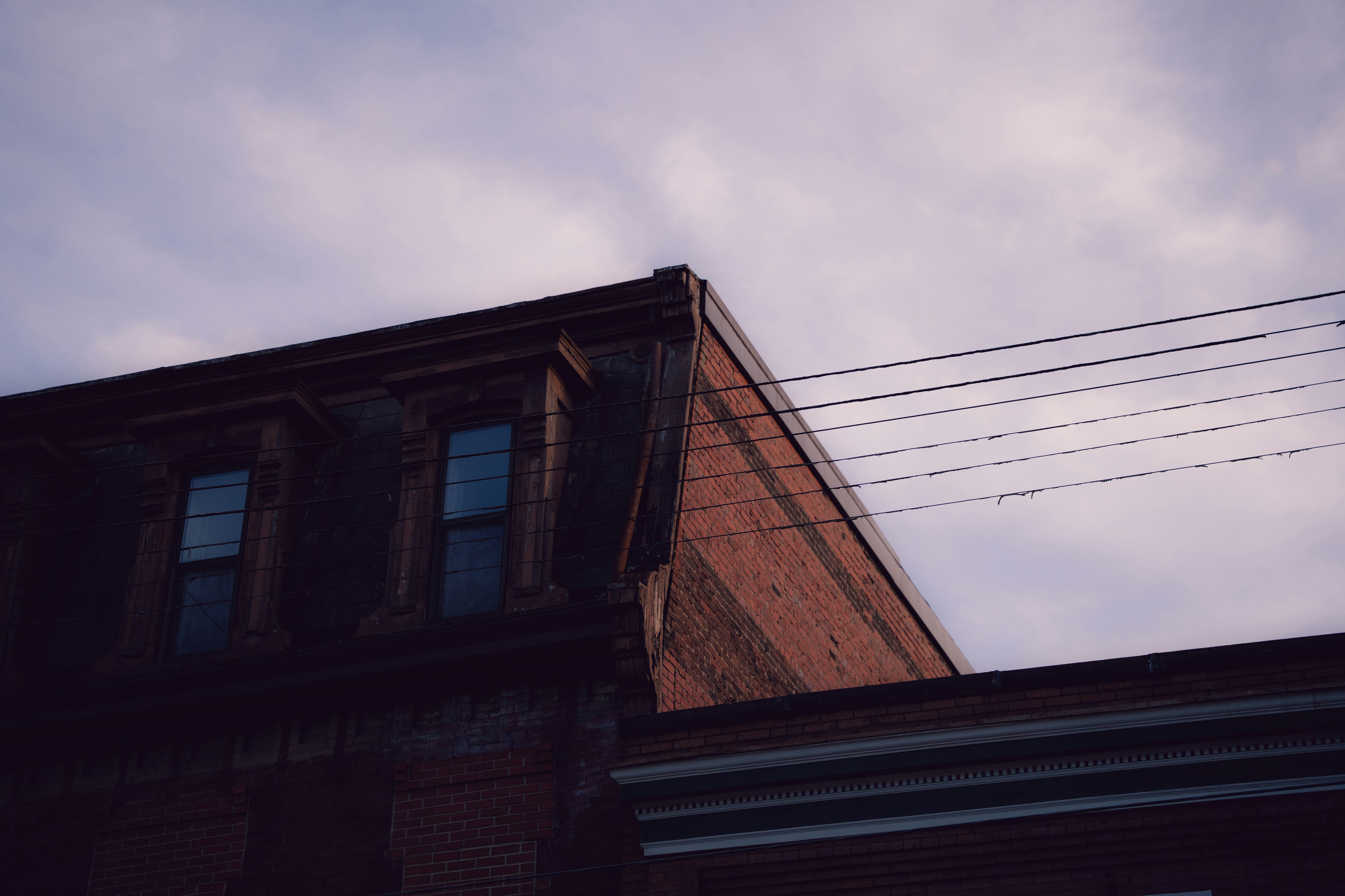 Brick Corner Under a Sky of Soft Purple Clouds