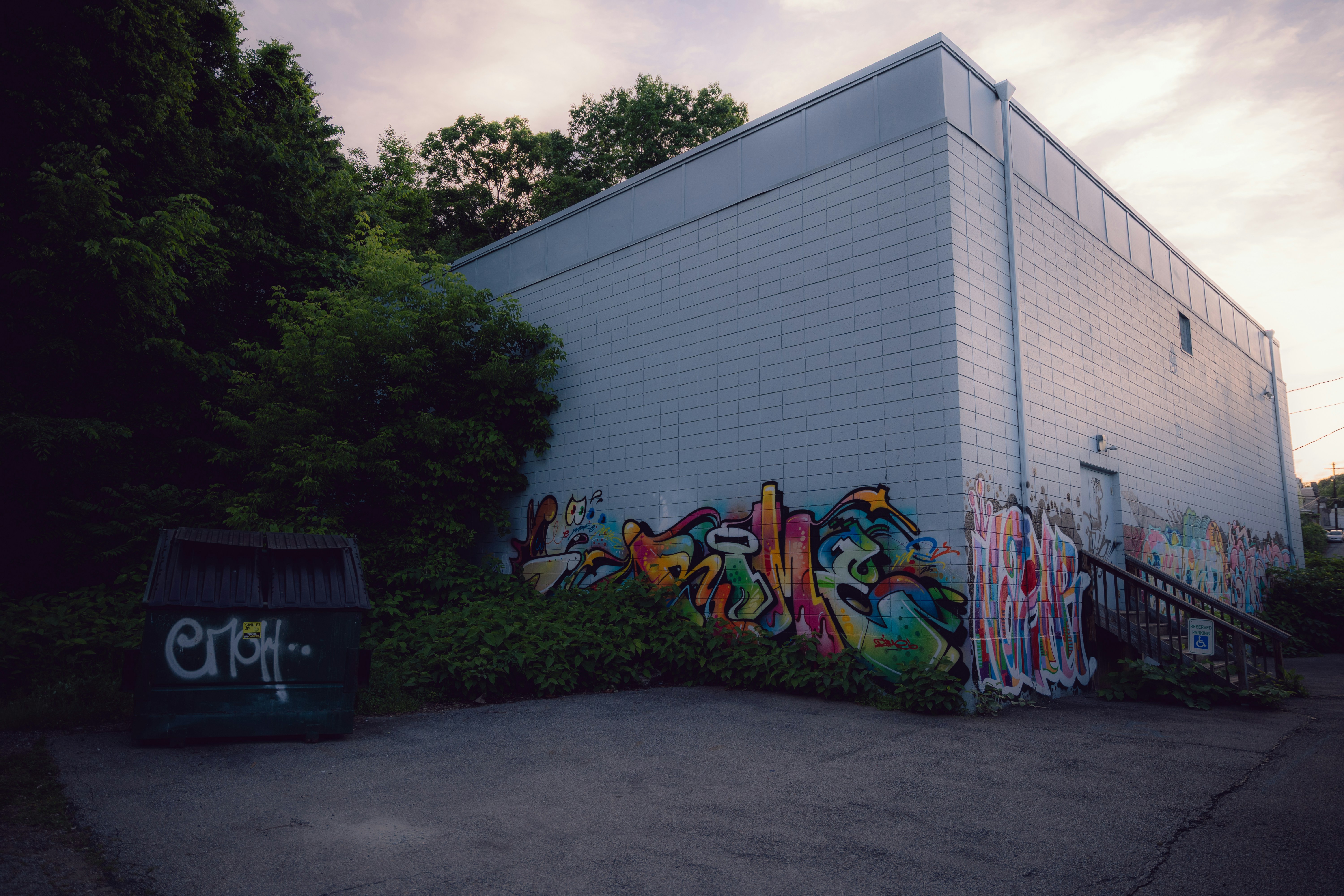 Graffiti-Fueled Wall Adorns an Industrial Annex at Dusk