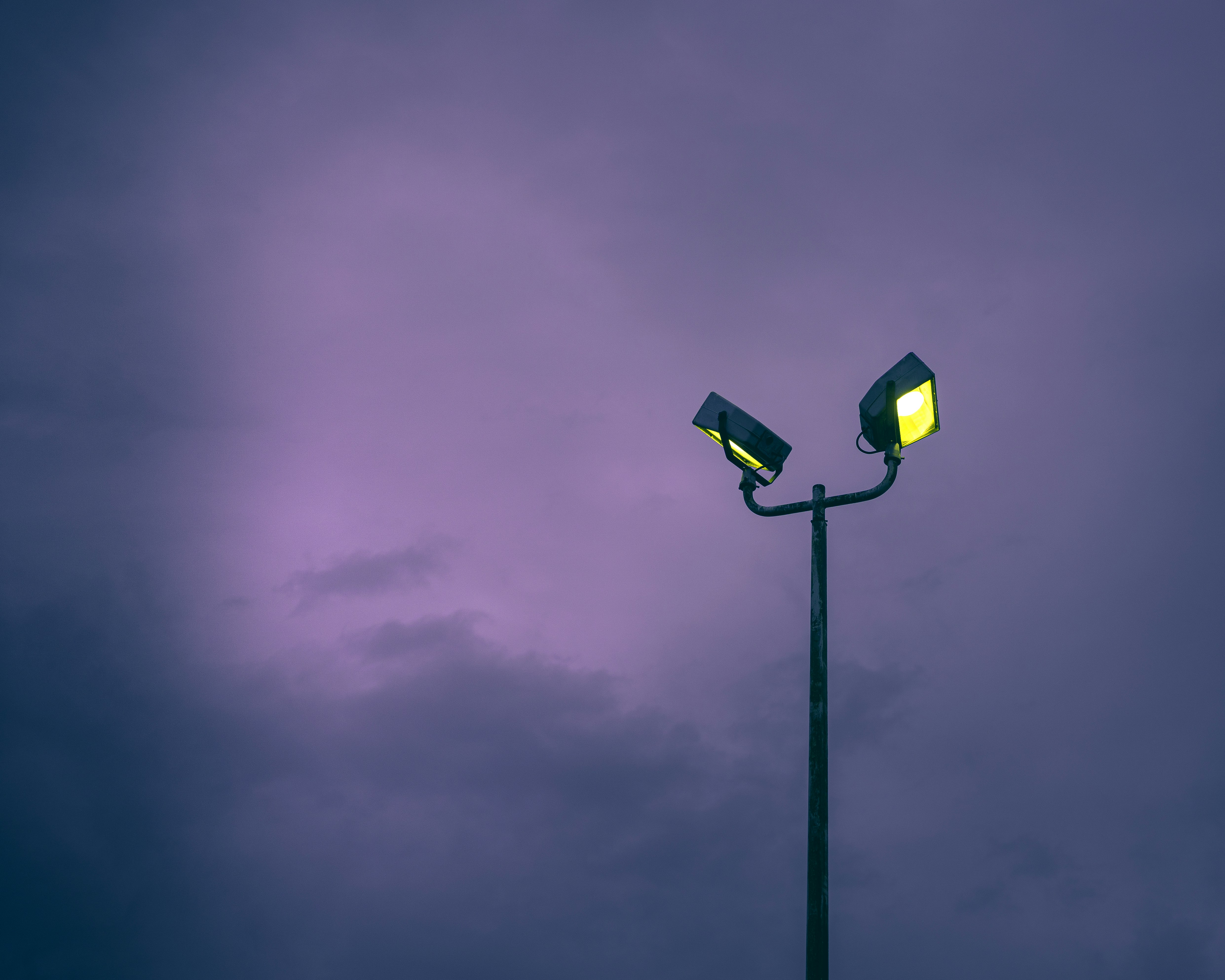 Midnight Beacons: Dual Floodlights Against a Quiet Evening Sky