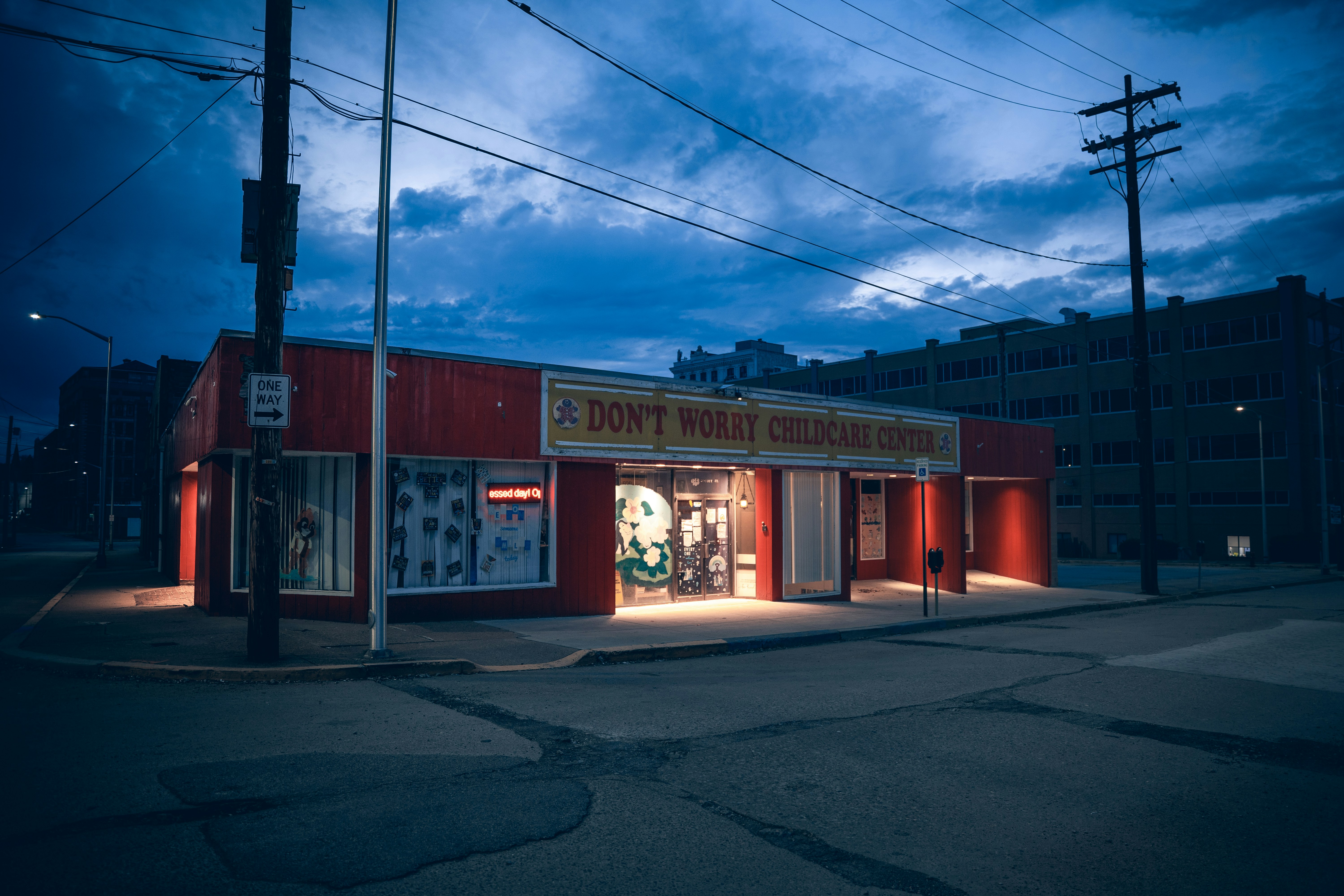 Neon-lit Don’t Worry Childcare Center at Dusk
