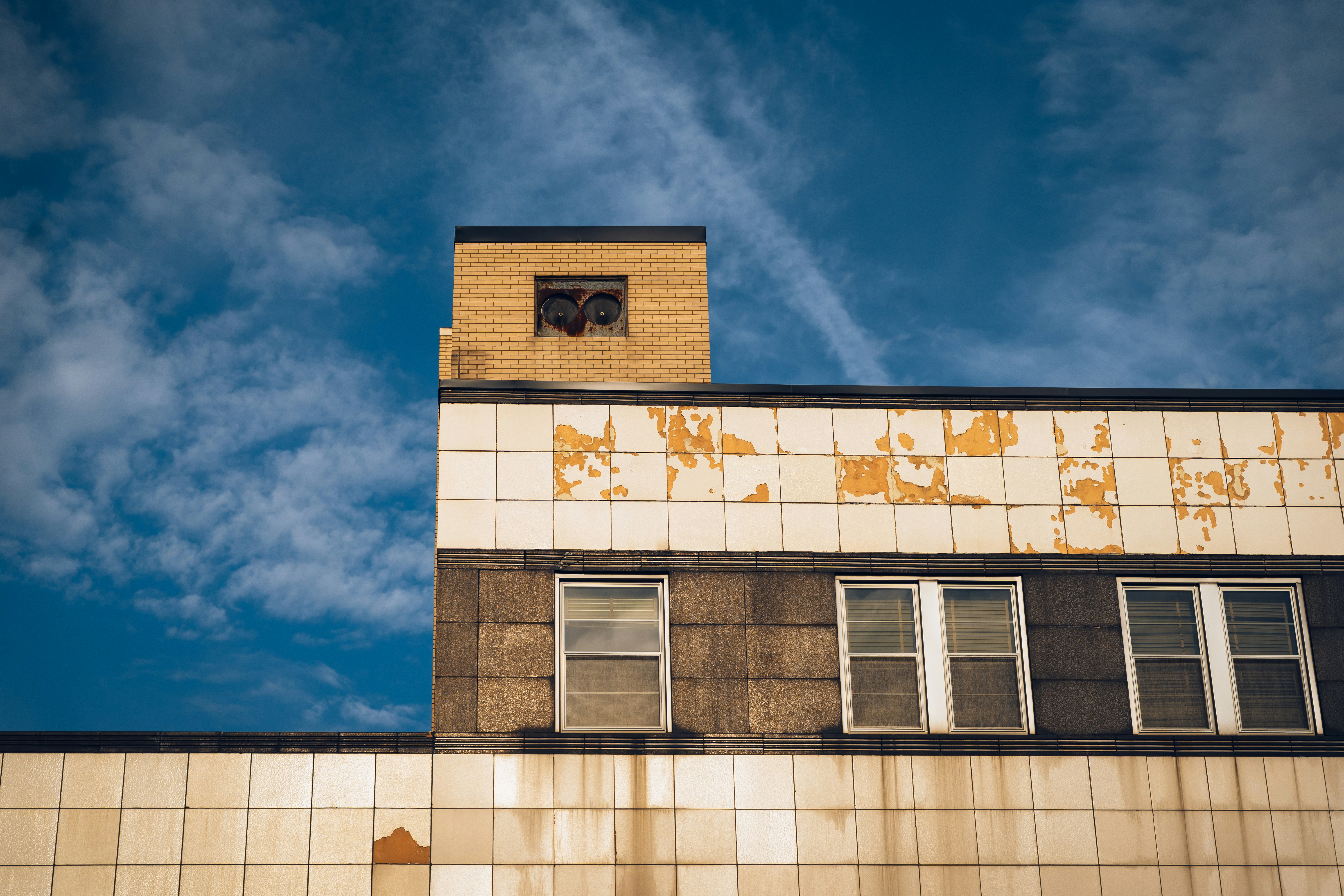 Weathered brick tower peeking over the rooftop