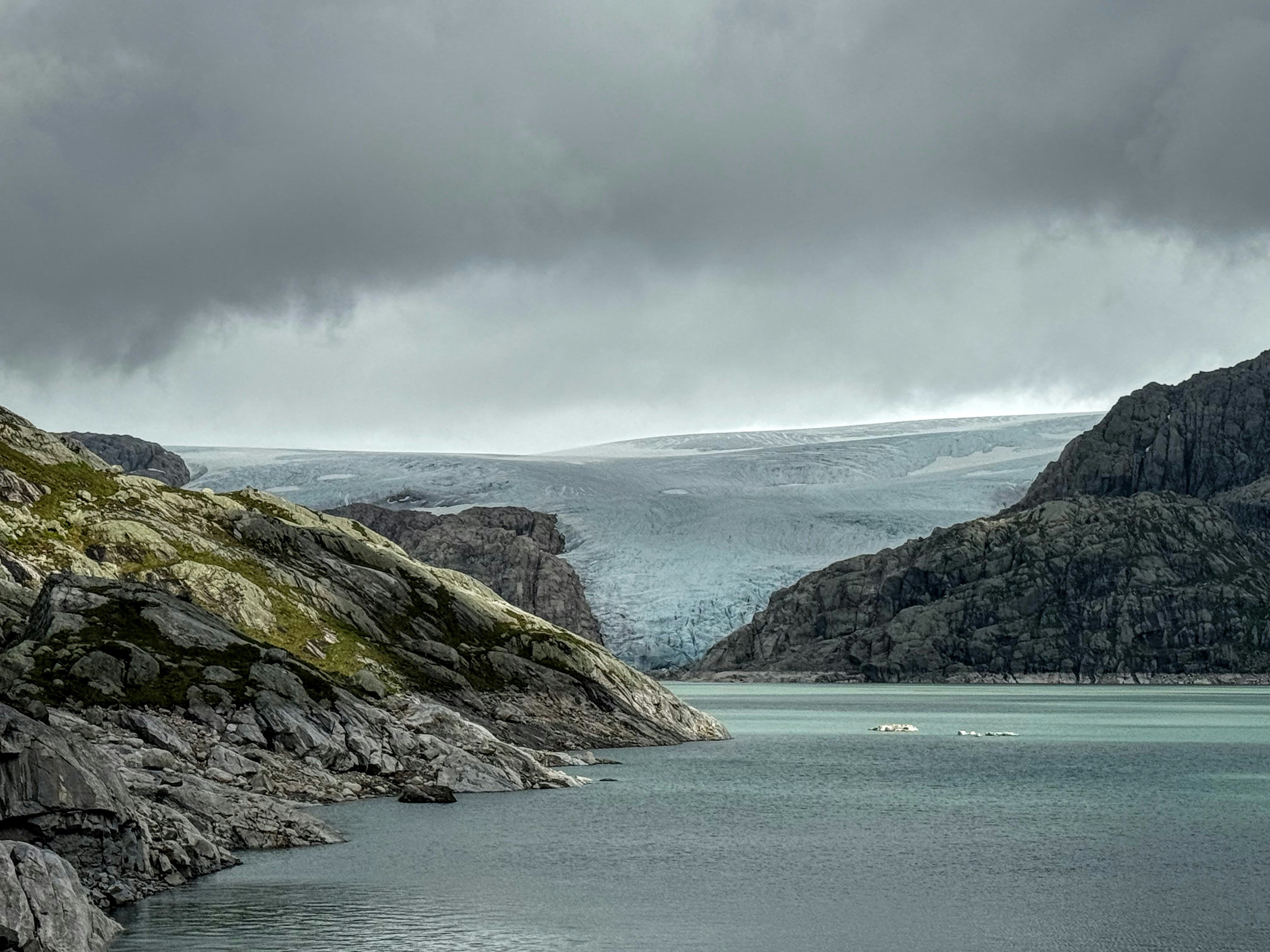 Glacial Cove Under Clouded Sky