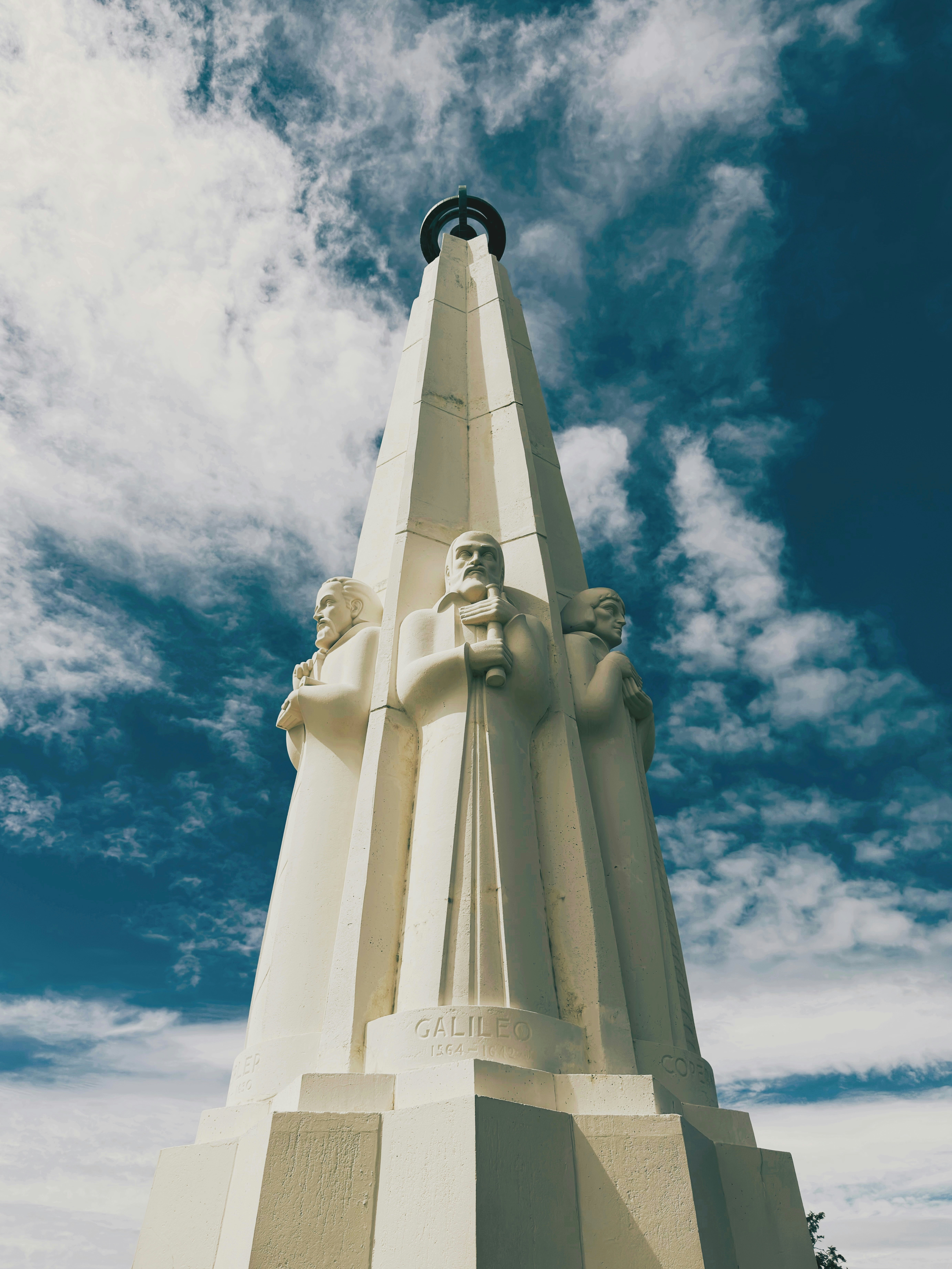 Monumental Obelisk: Carved Figures Reaching Toward the Sky