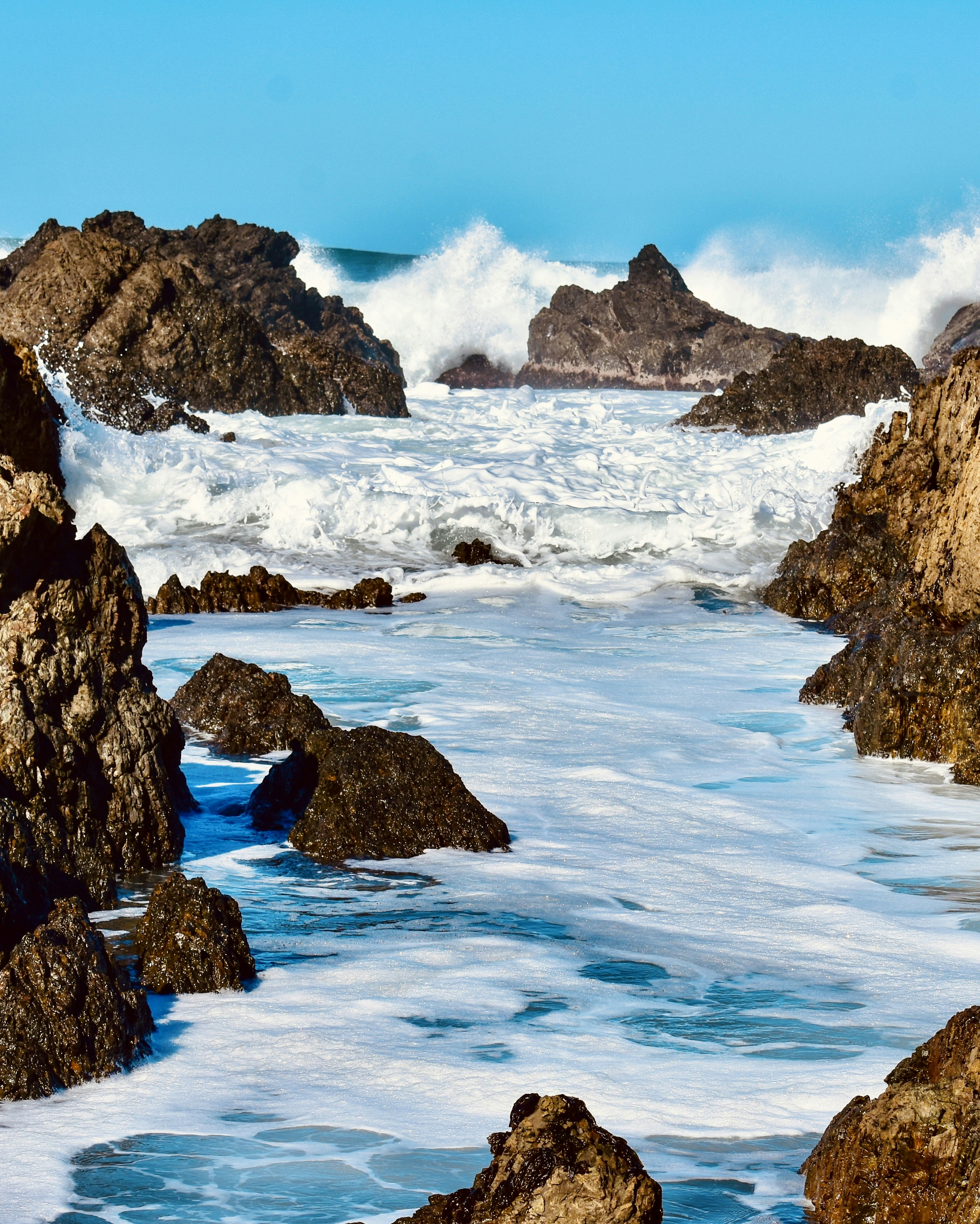 Foamy Crest Beyond the Jagged Shore
