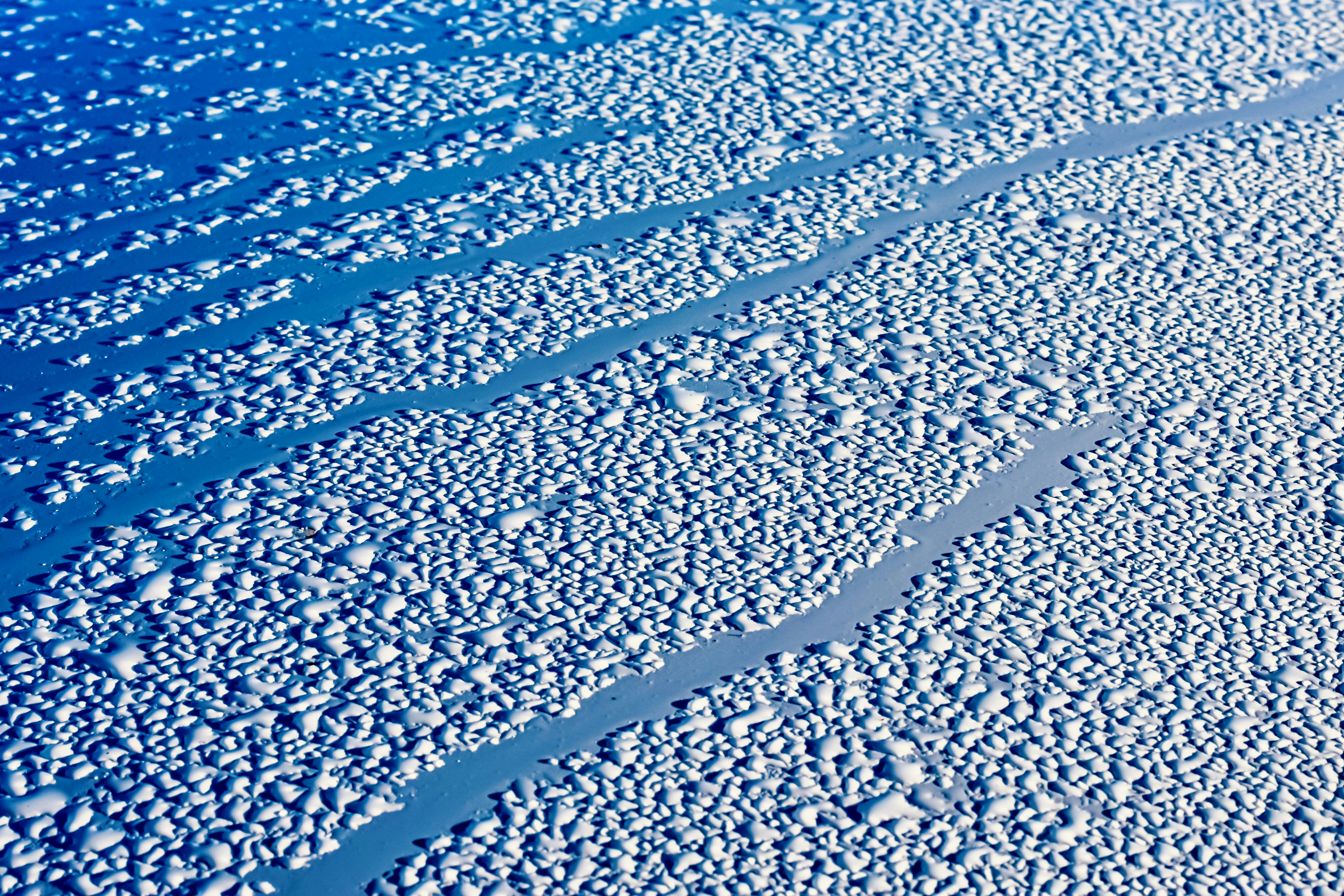 Glacial Ripples: Aqua-White Textures on Frozen Sea Surface
