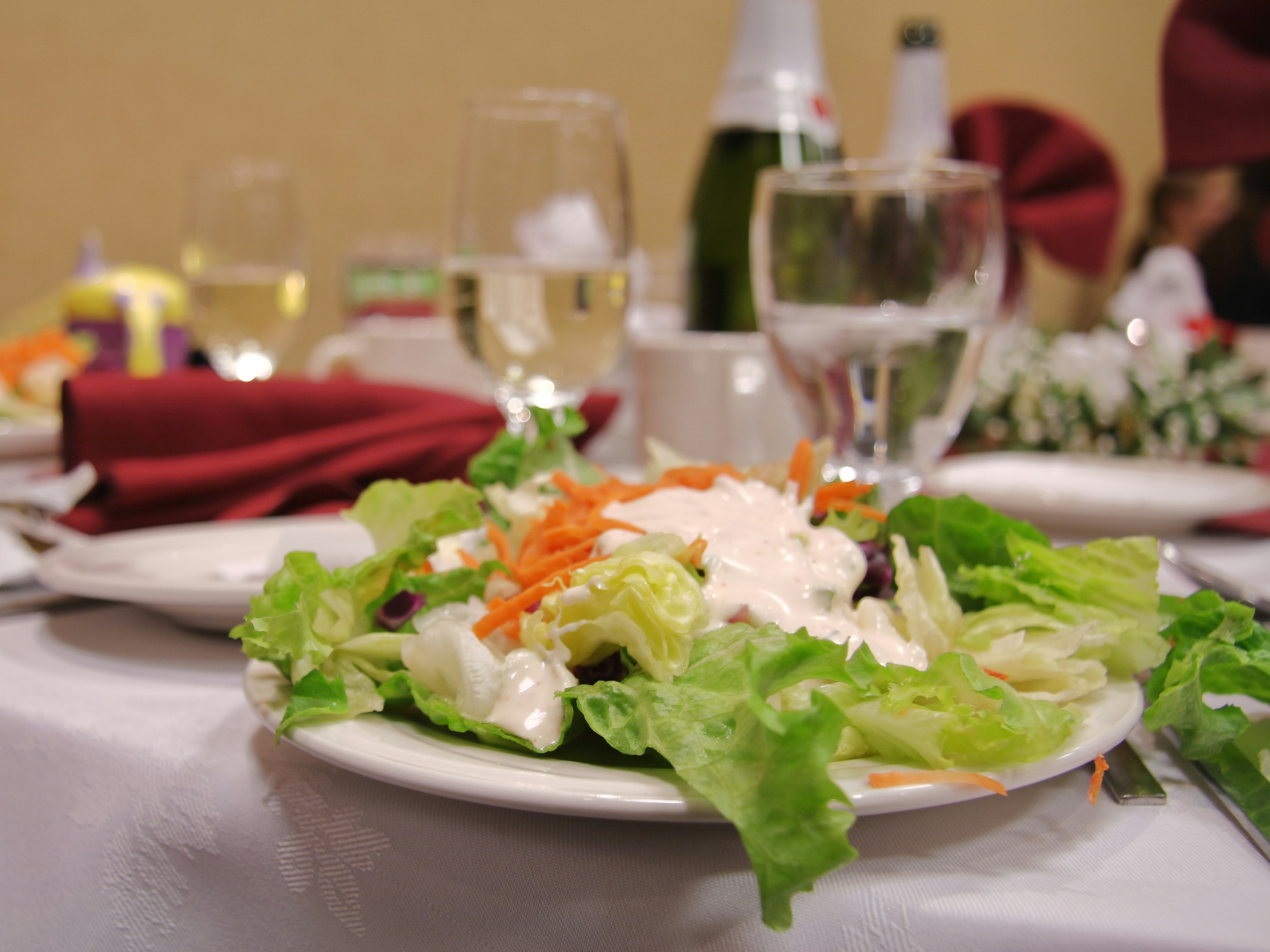 Lush Salad Centerpiece Beneath a Toasting Glassware Scene