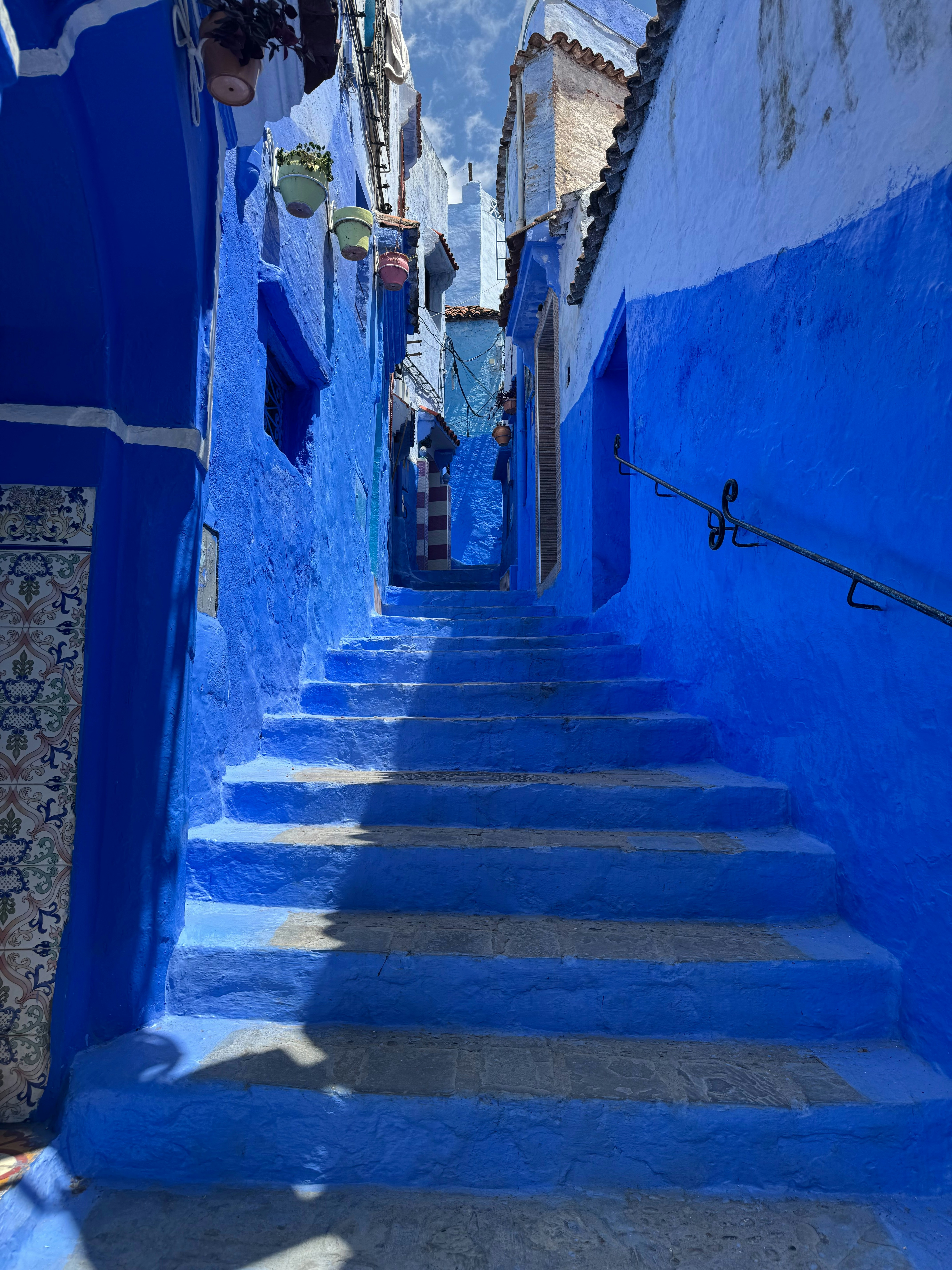 Stairway to cobalt: a sunlit blue-washed alley up the heart of Chefchaouen