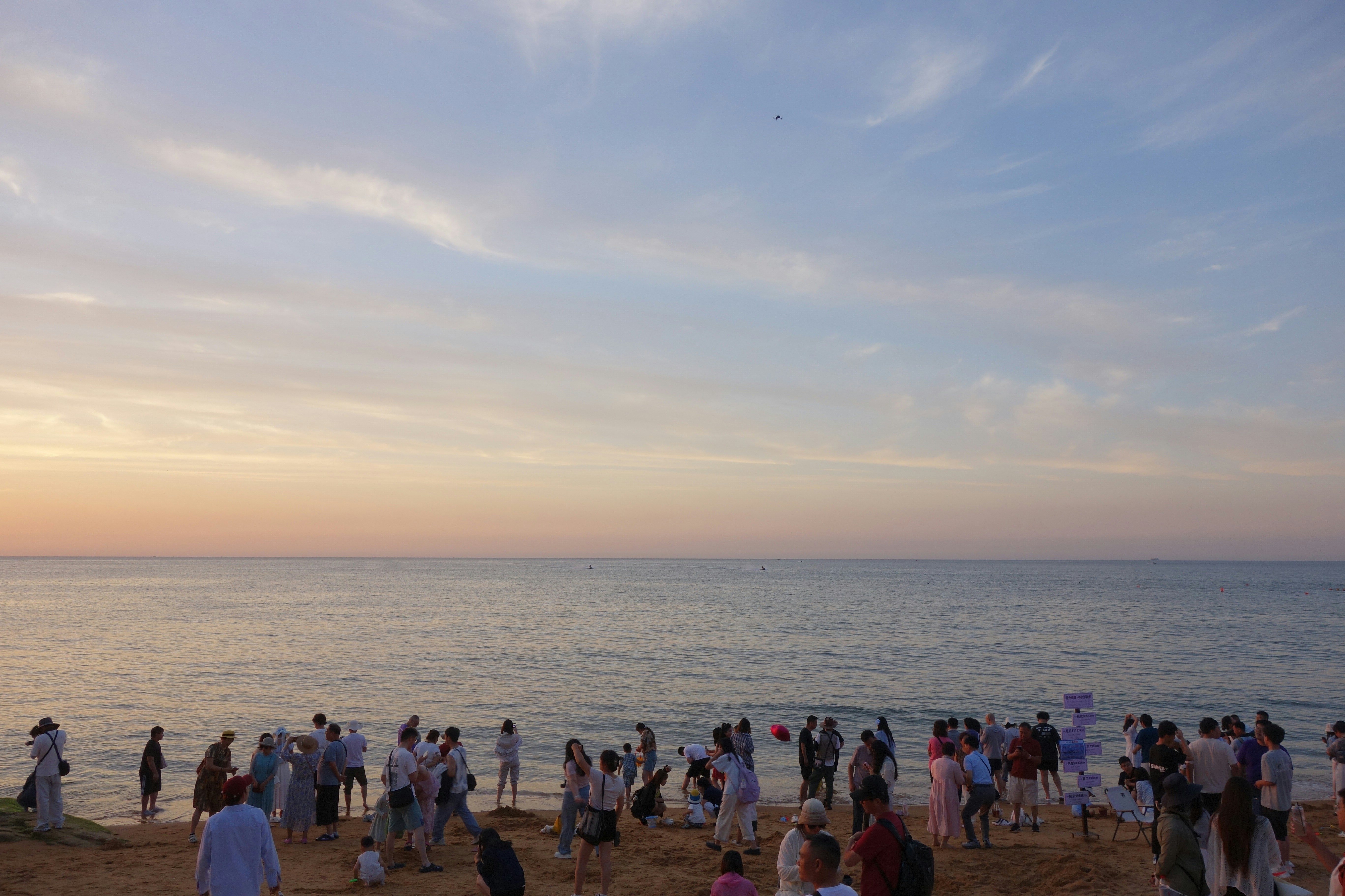 Sunset Beach Gathering: A Quiet Sea of People at Dusk