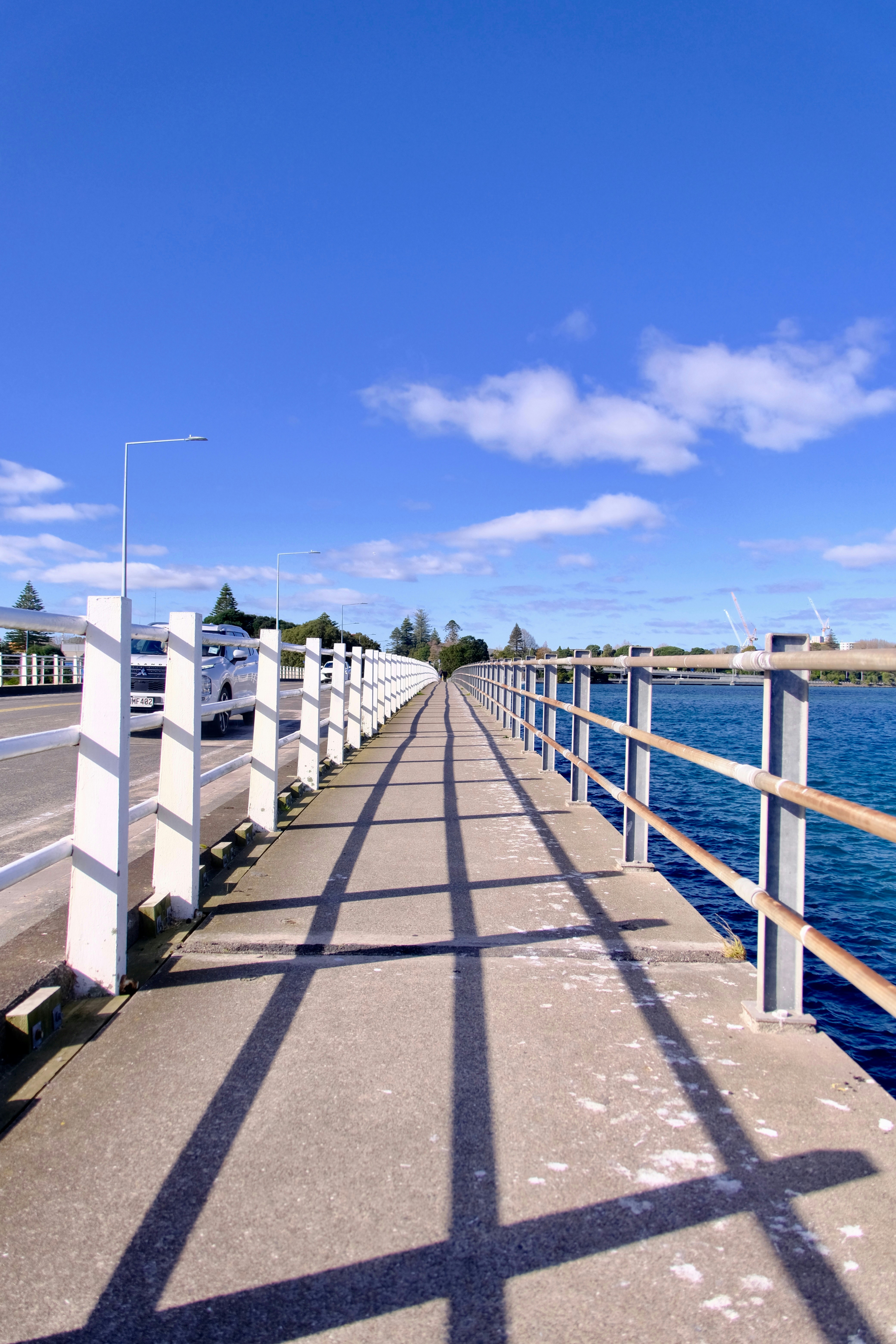 Long Pier Toward the Vanishing Point Under Wide Blue Sky