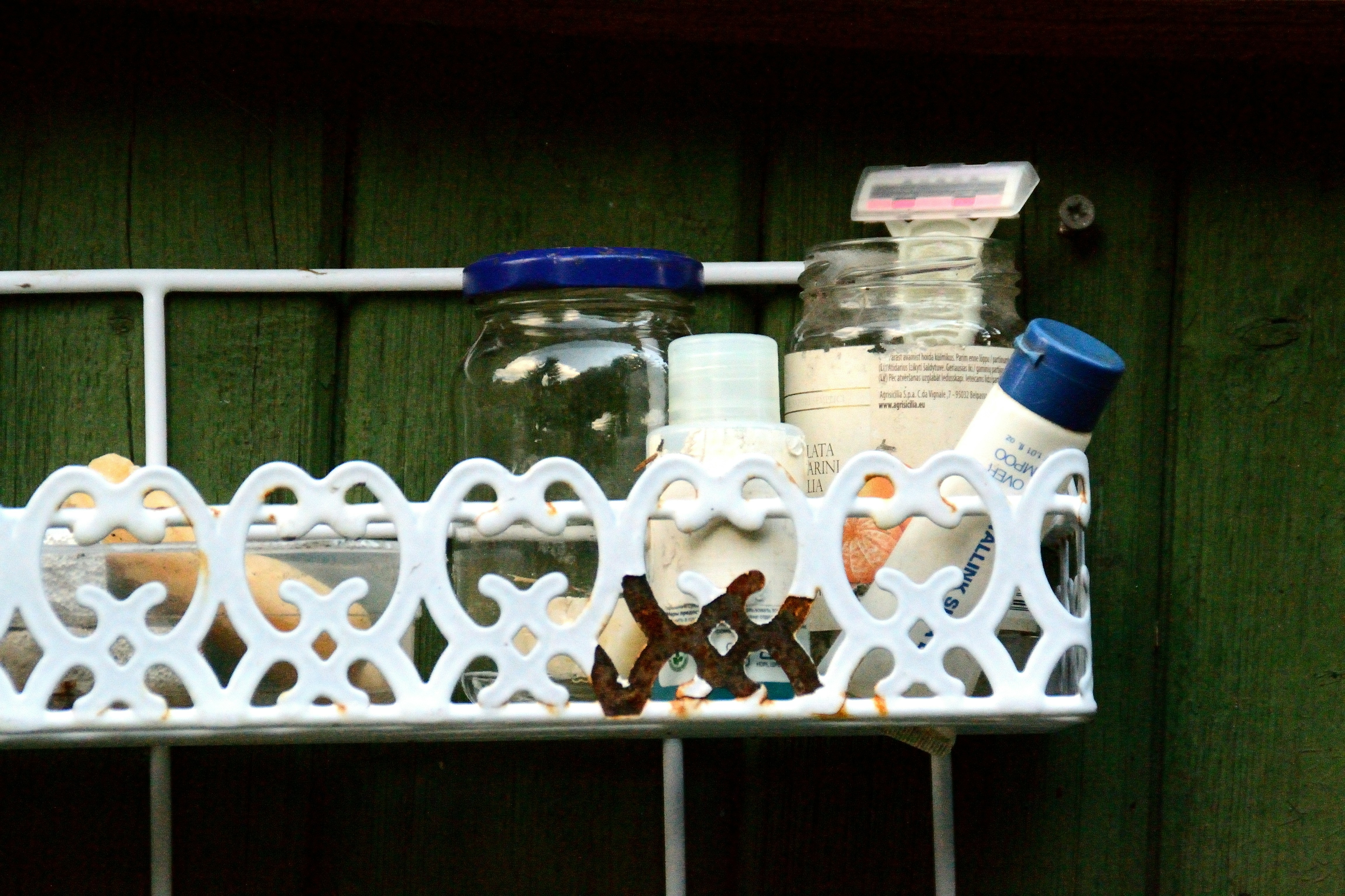 Nostalgic shelf still life: jars and bottles resting in a decorative basket