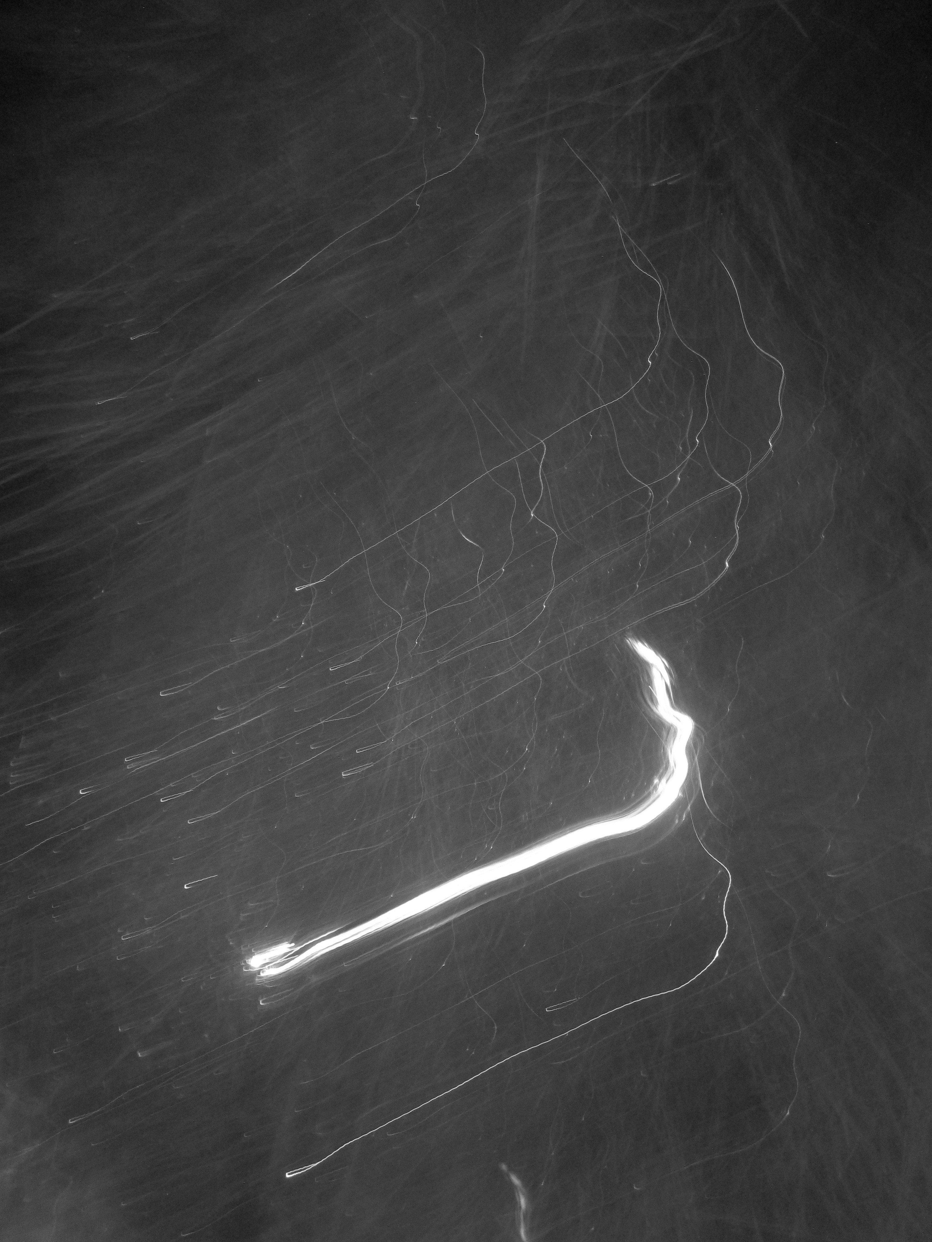 Luminous Spiral: A Trail of Light Across Night Shallows