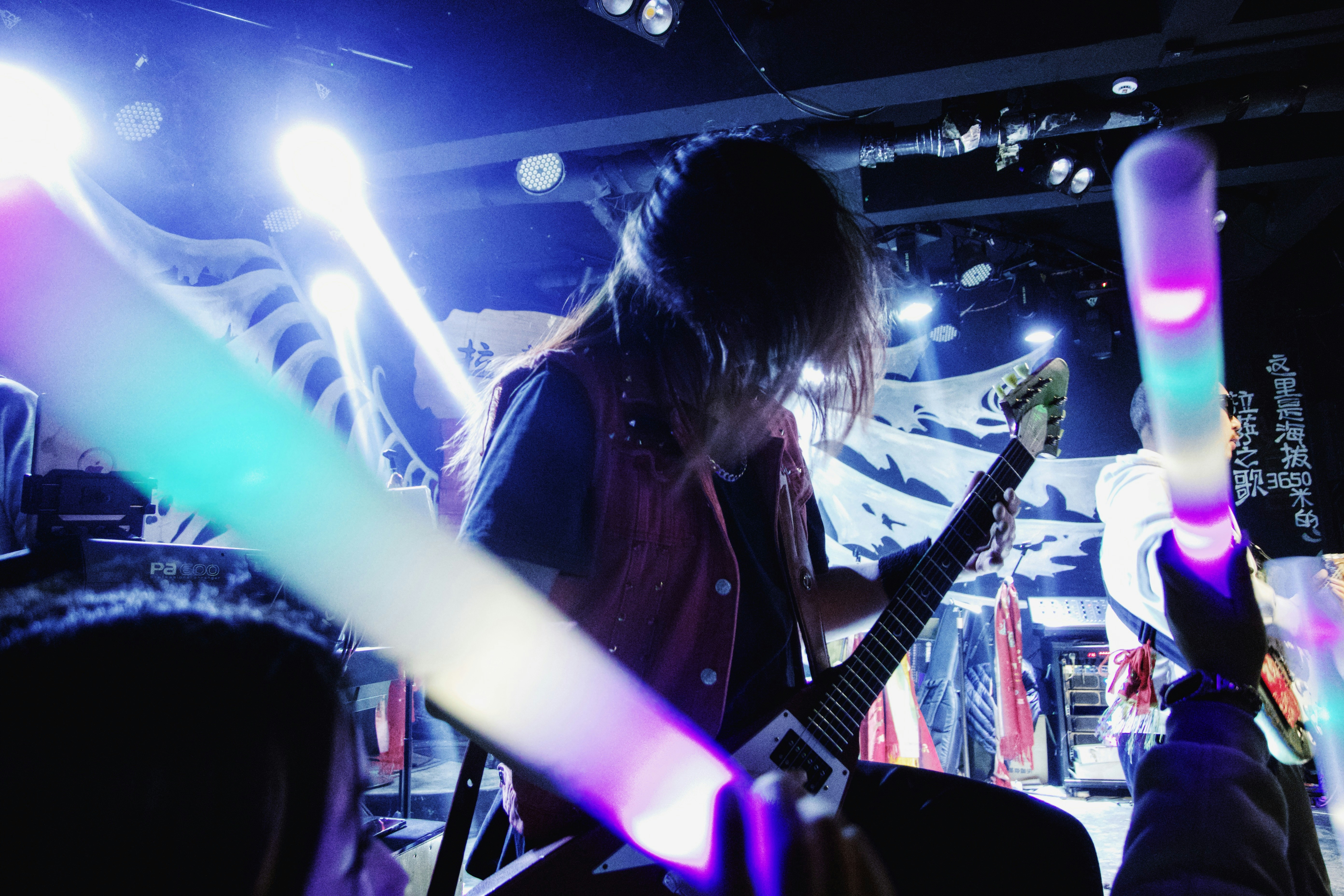Neon Doomed Strings: A Guitarist Drenched in Stage Light