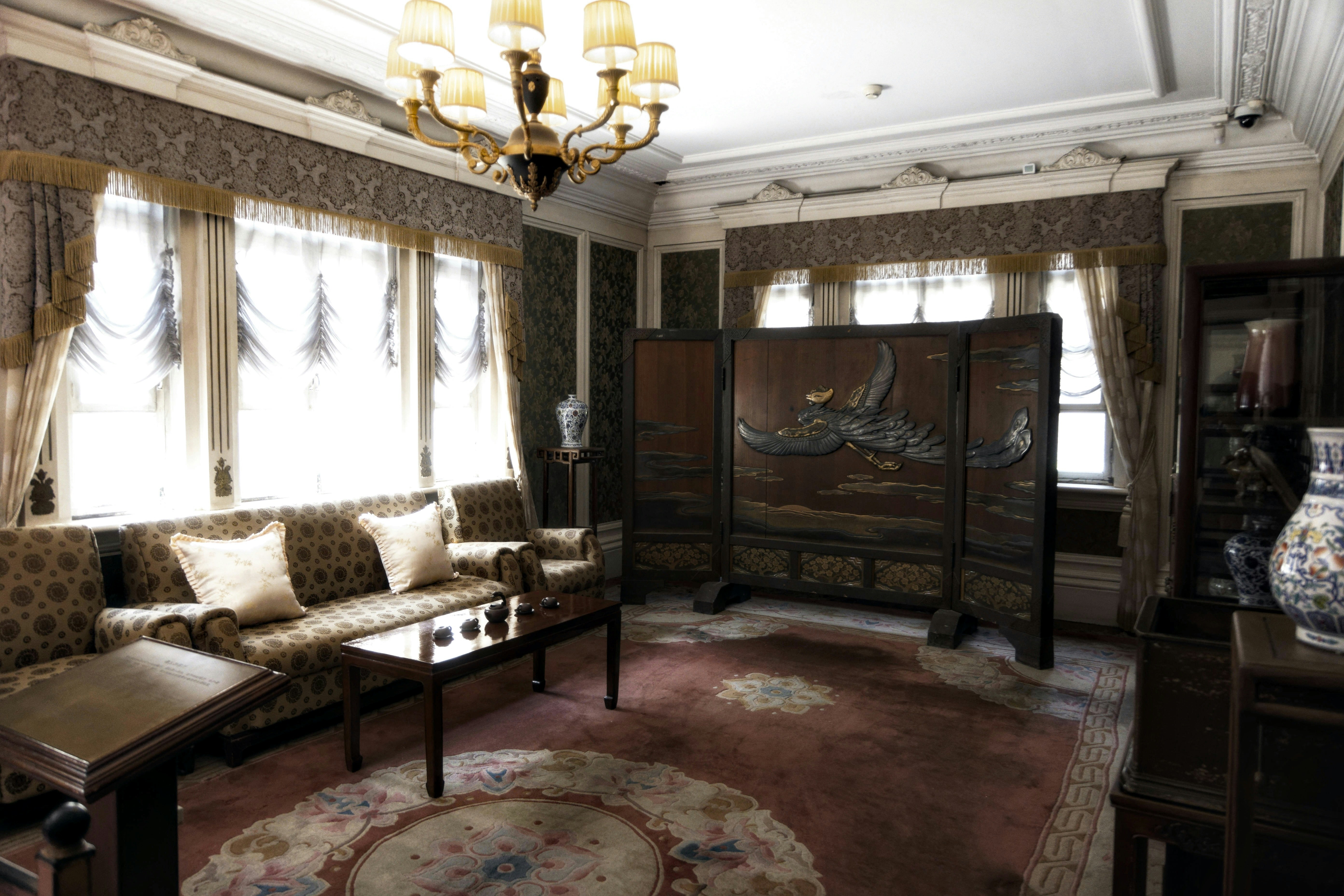 Elegant Parlor with Vintage Screen and Plush Seating