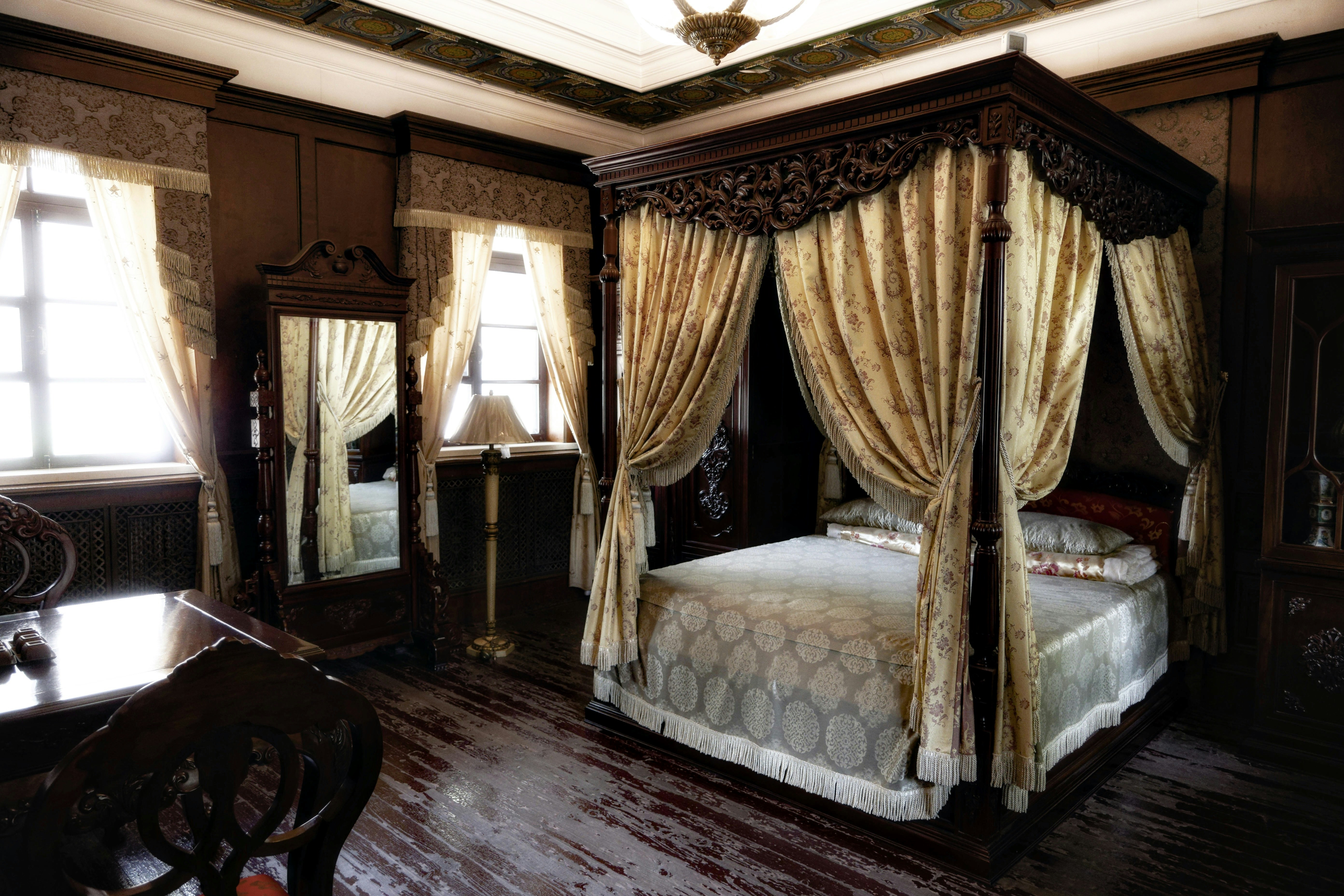 Regal Canopy: An Antique Bed Beneath Velvet Drapes