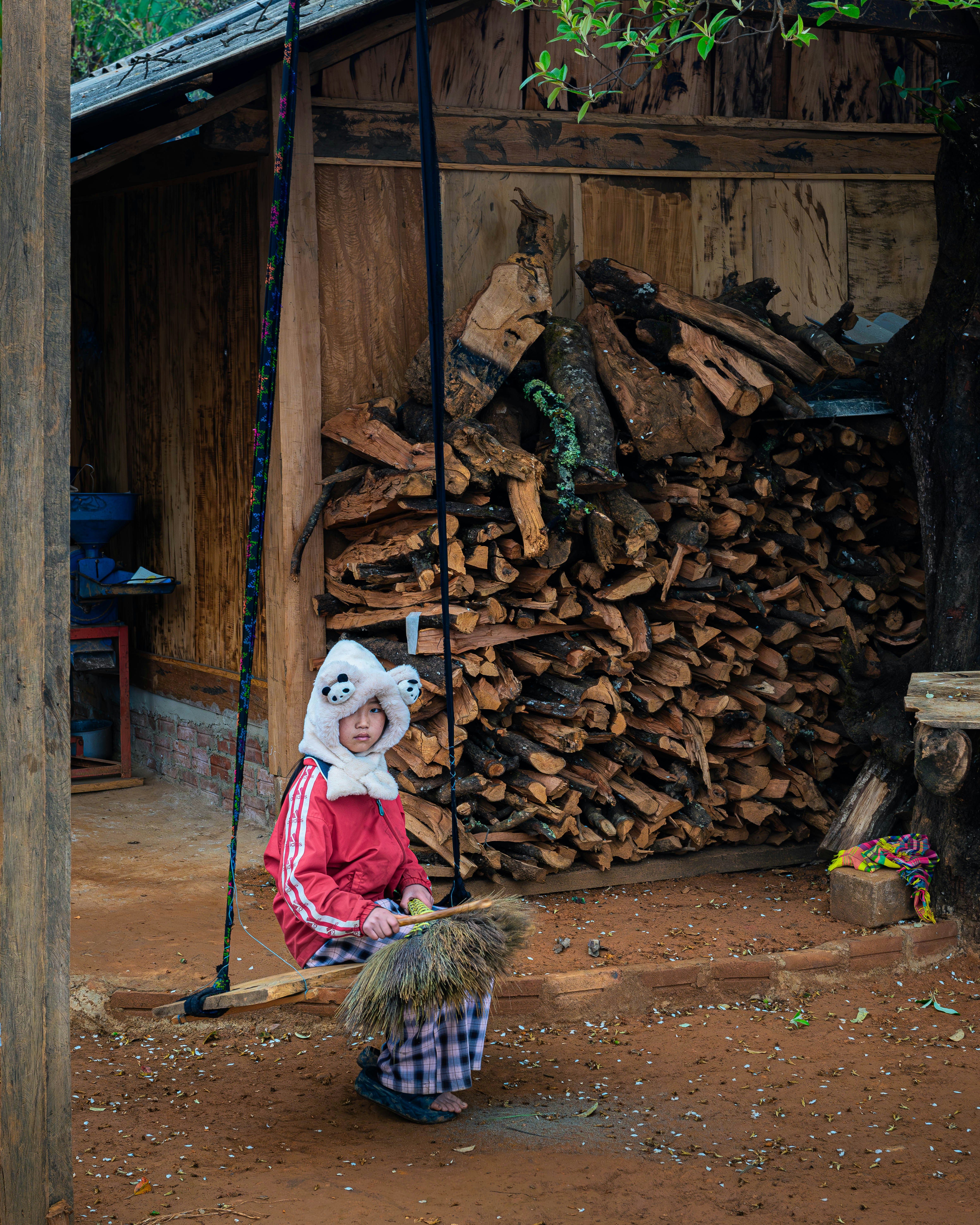 Child on a Swing Woven with Straw: Quiet Rural Moment