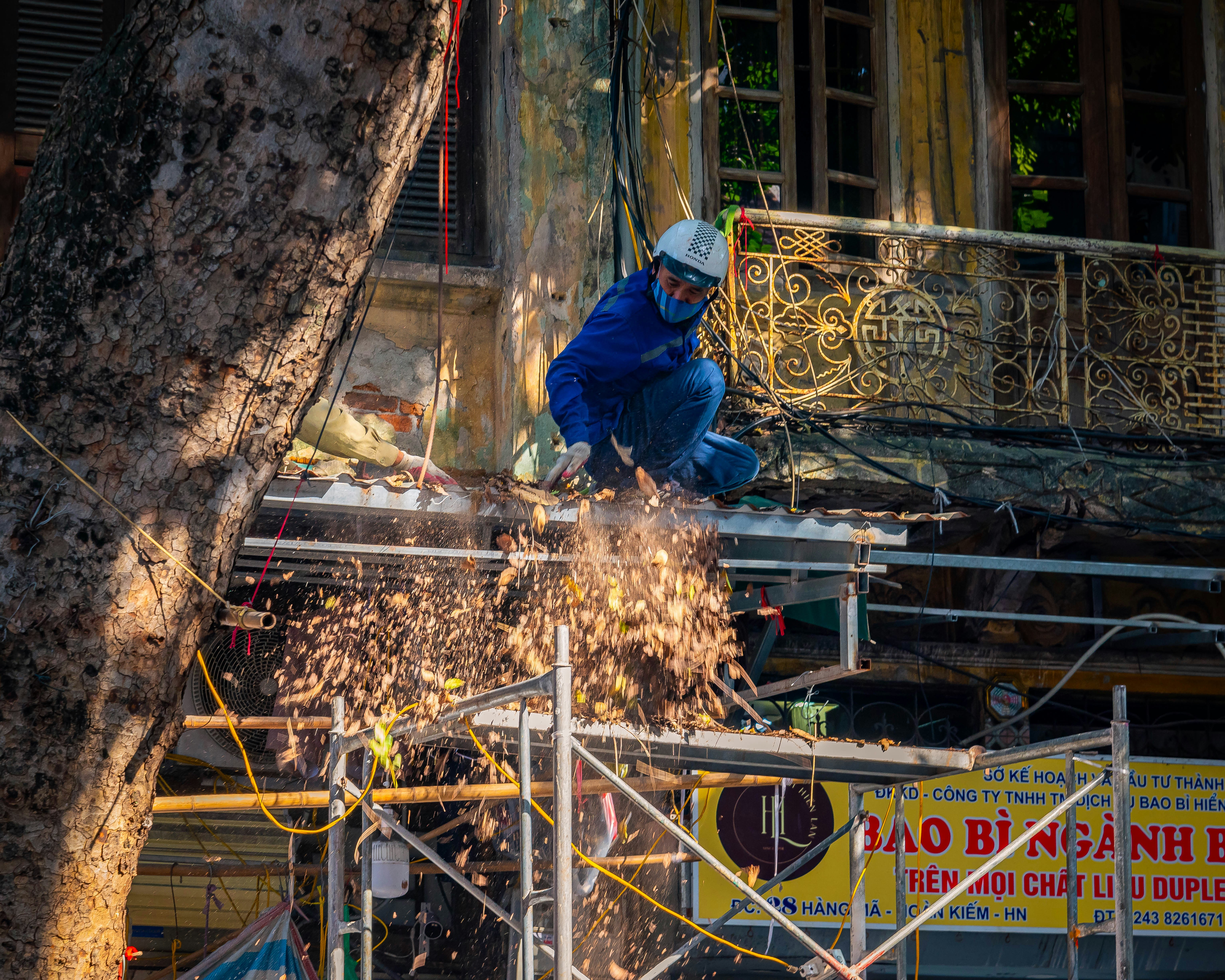 Sparks and Steel: Worker On a Balcony During Night Work