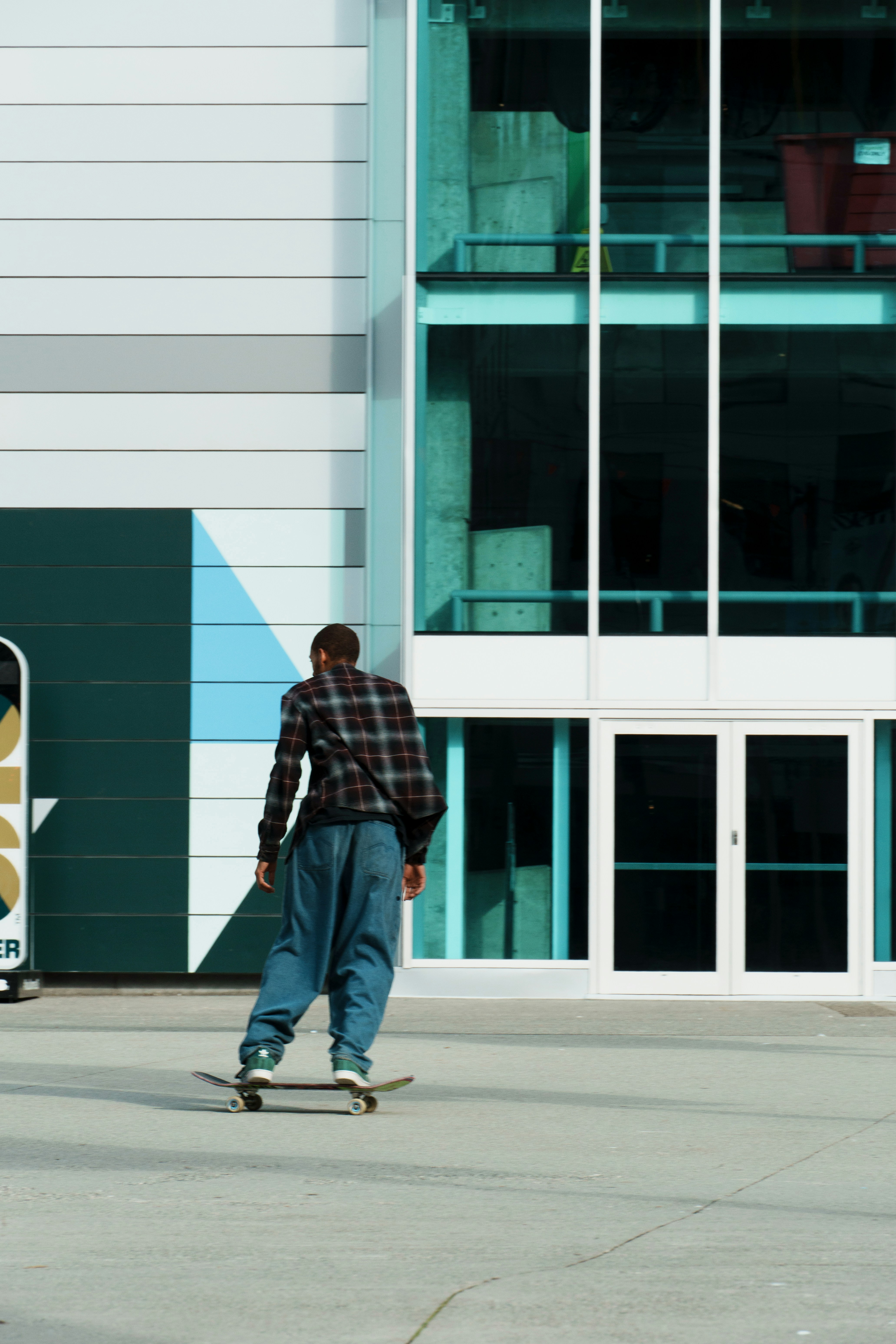 Skater in Front of a Modern Glass Facade