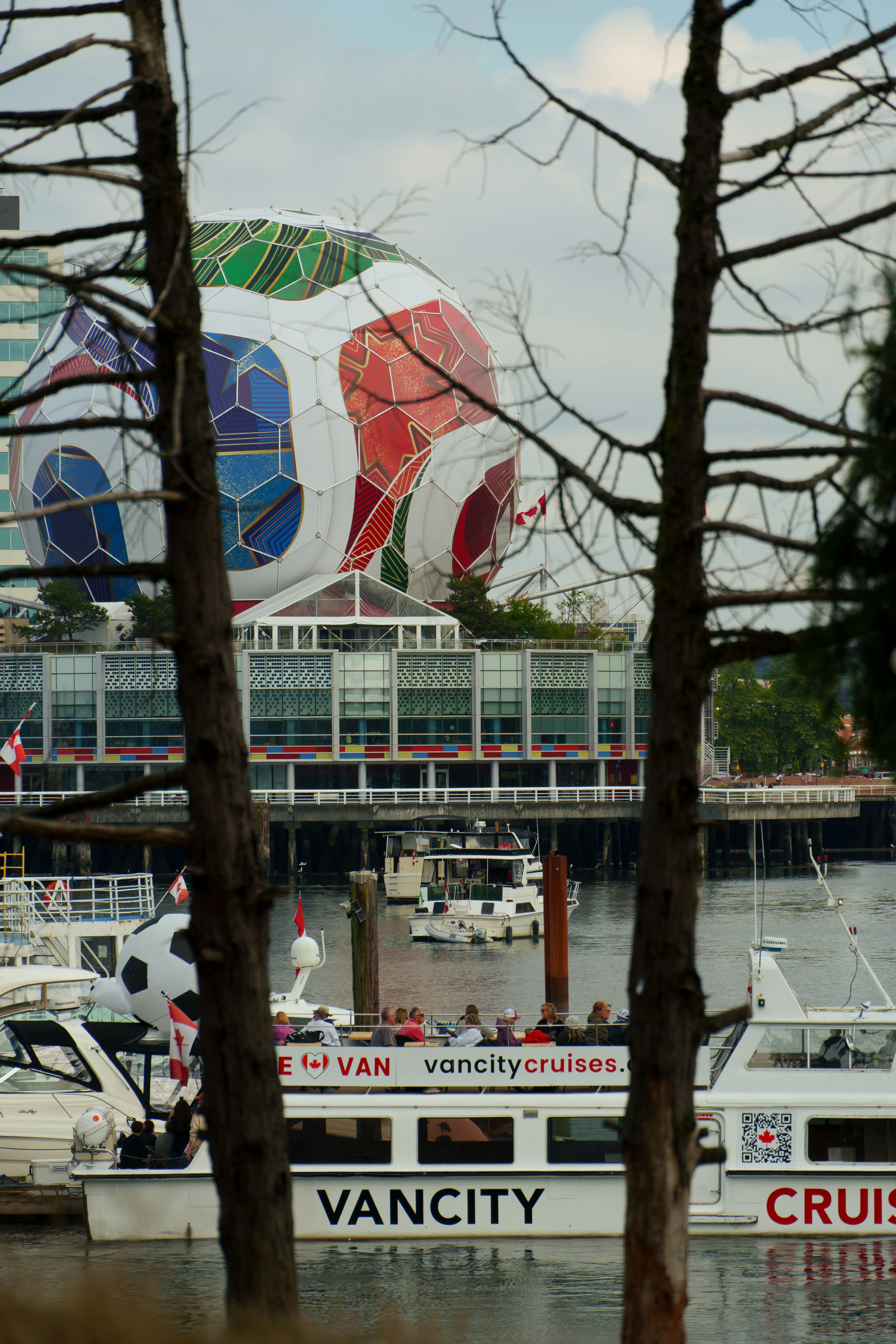 Geometric Giant Framed by Waterfront Trees