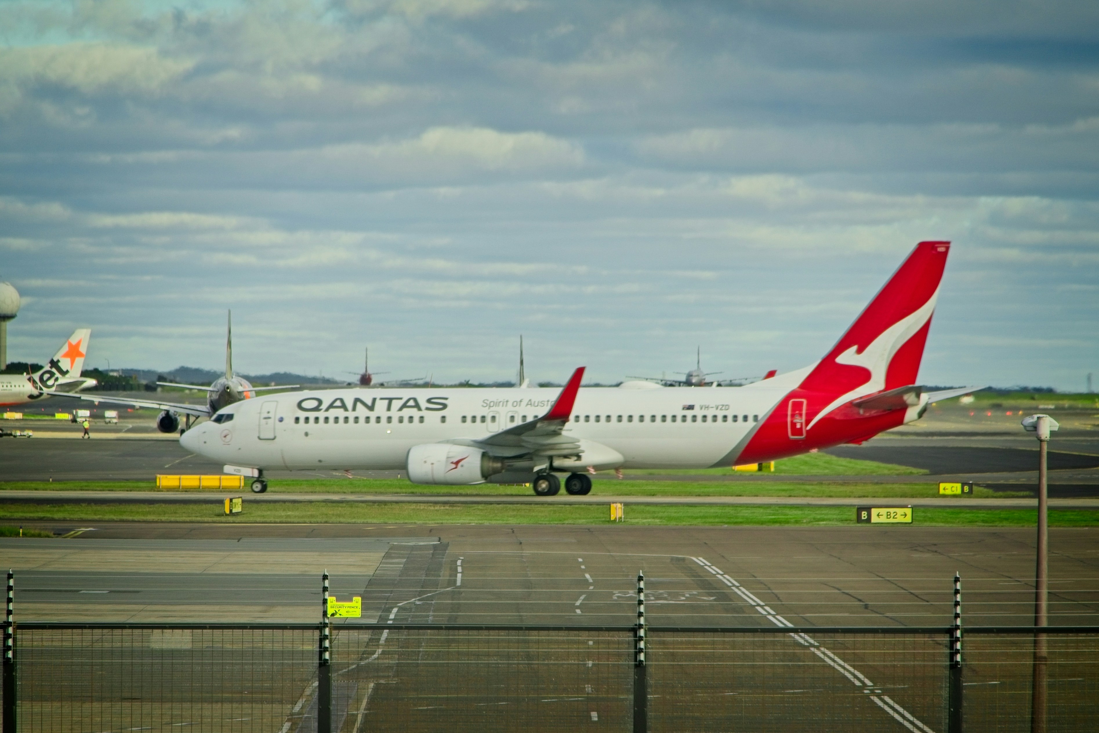 Red Qantas A320 on the Taxiway: Quiet Lull at a Busy Airport