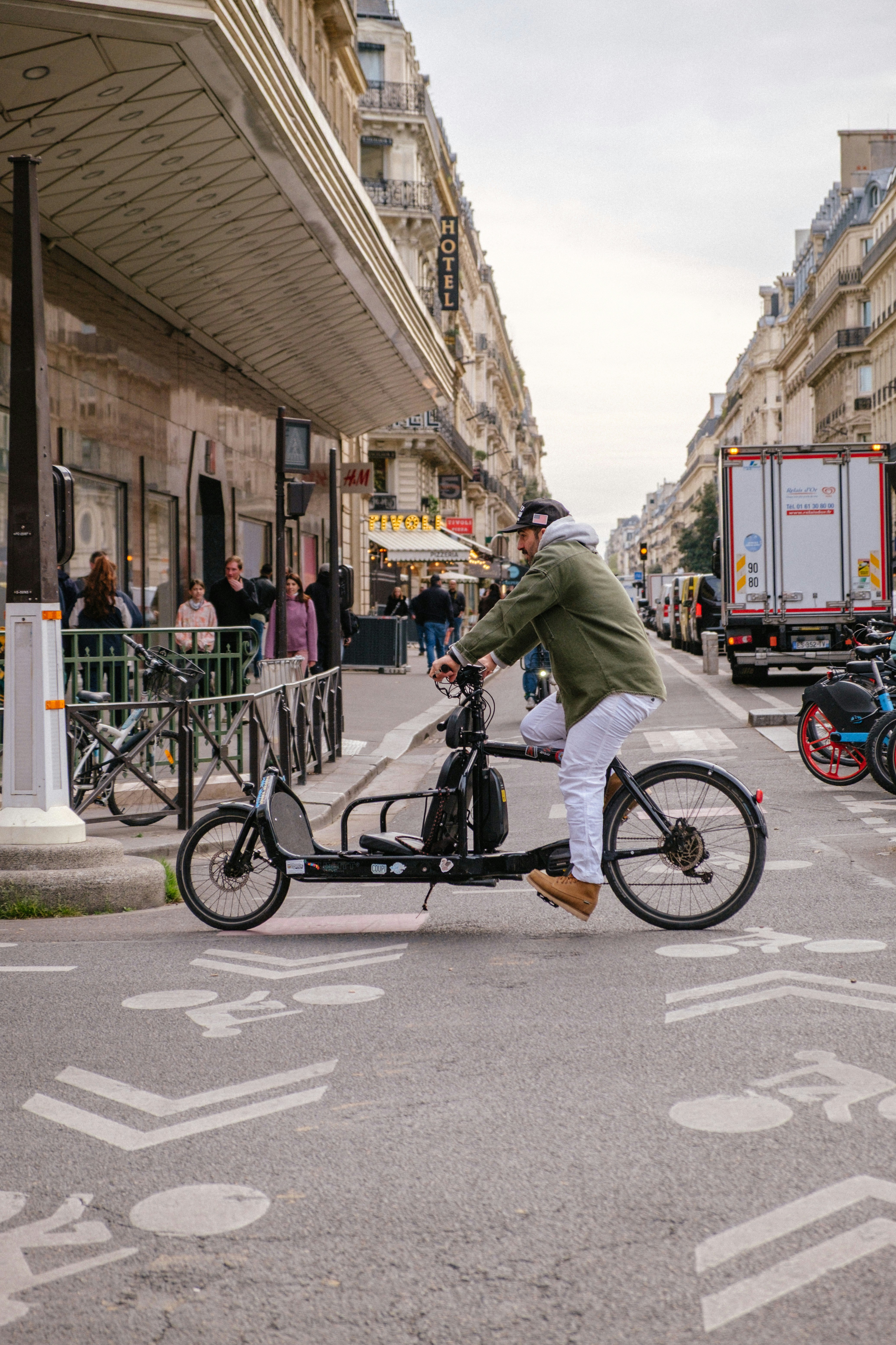 City Ride: A Pedal-Powered Scooter Steady in a Parisian Street