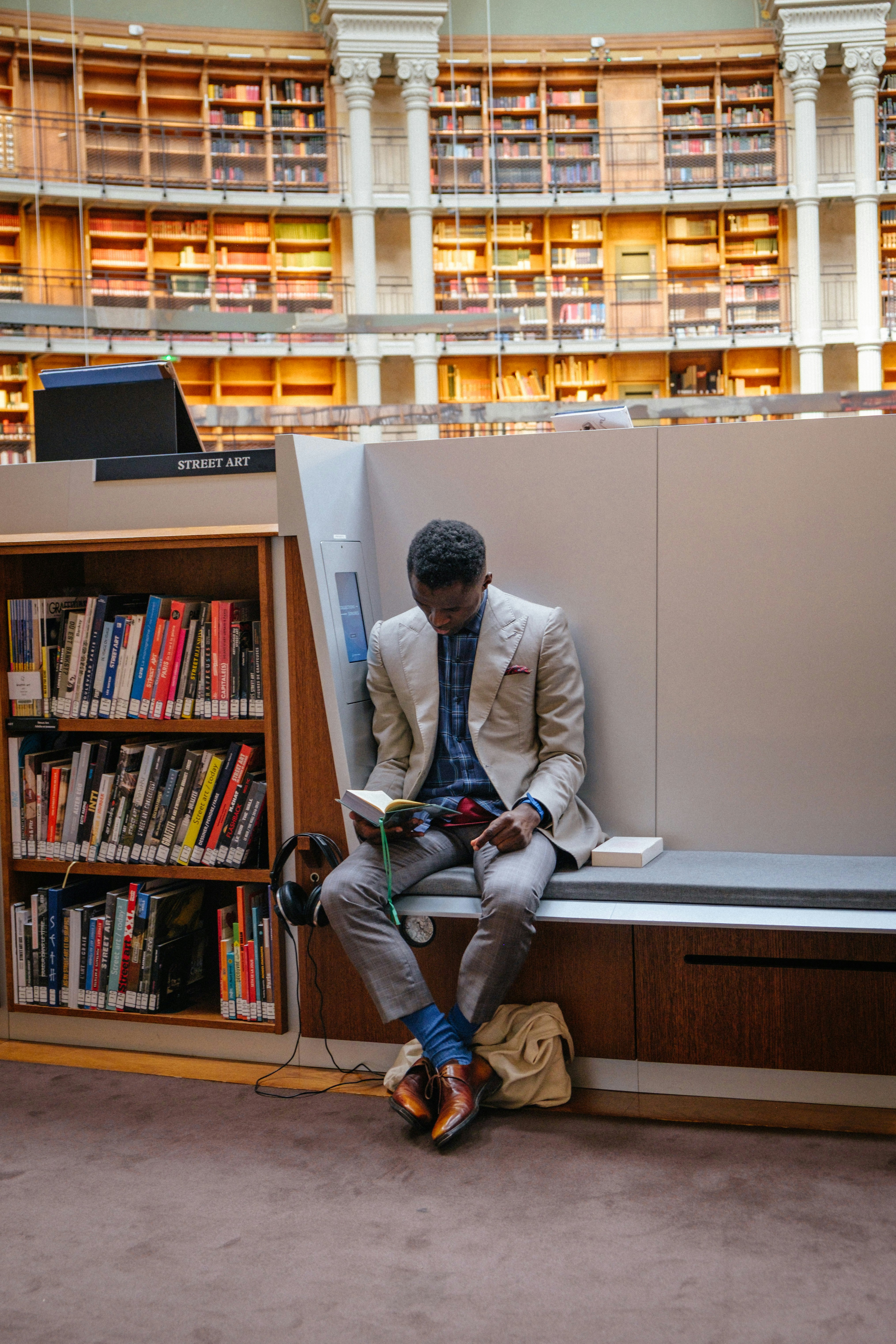 Reader in the Library Nook: Quiet Study Amidst Stacks