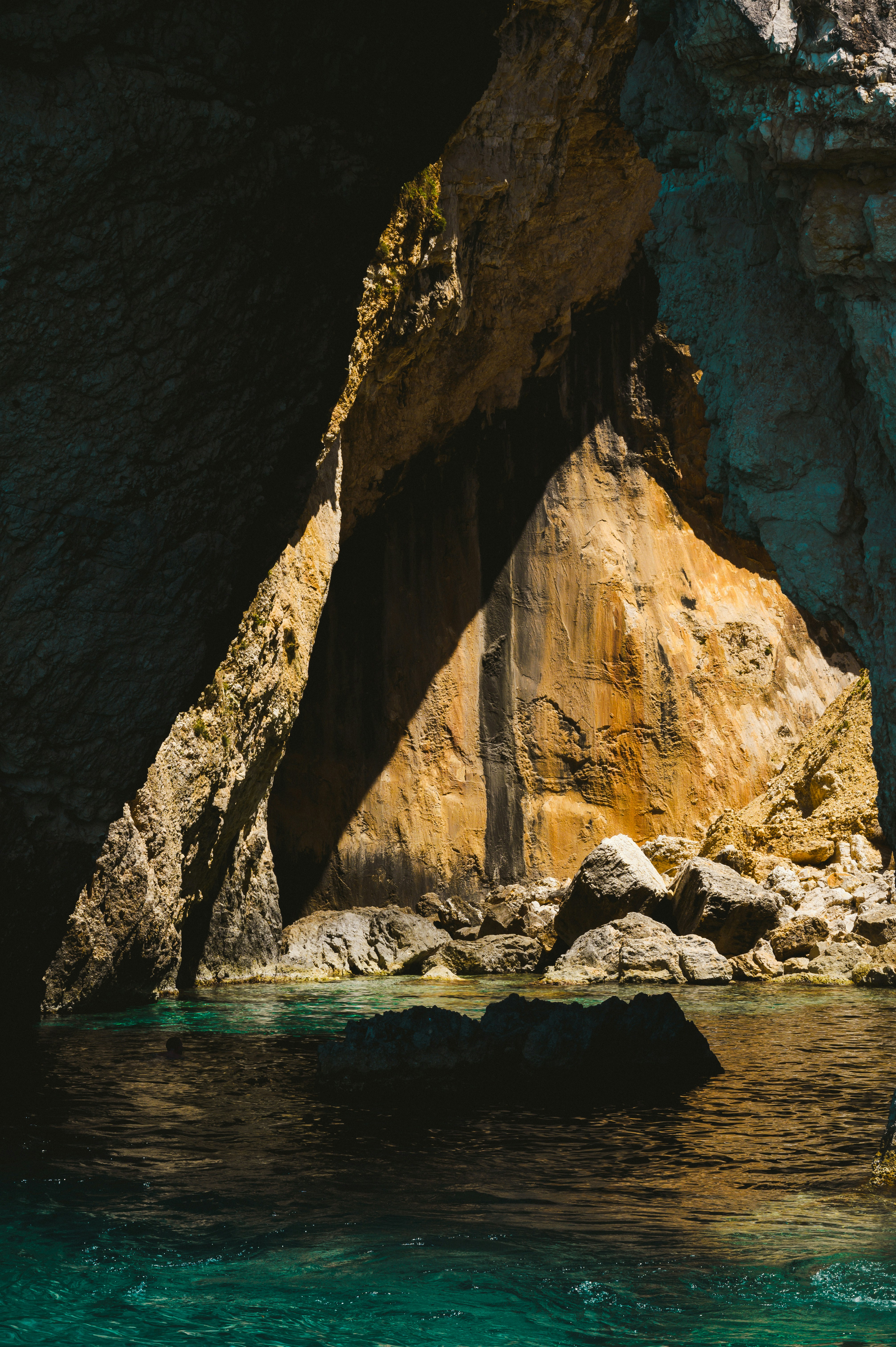 Sunlit Cave Veil Over Turquoise Tide