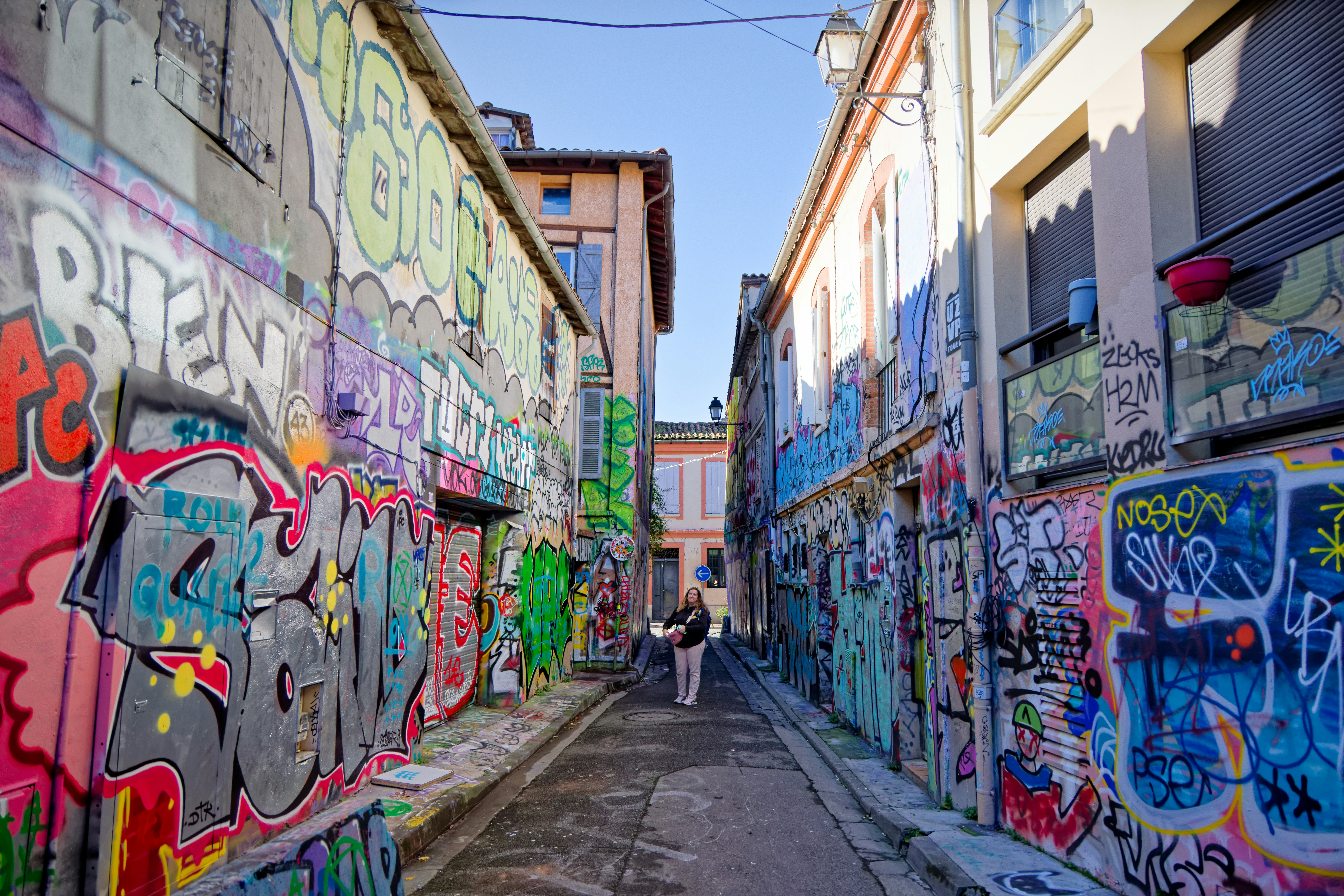 Graffiti Alley Convergence: Two Figures Amid Colorful Walls