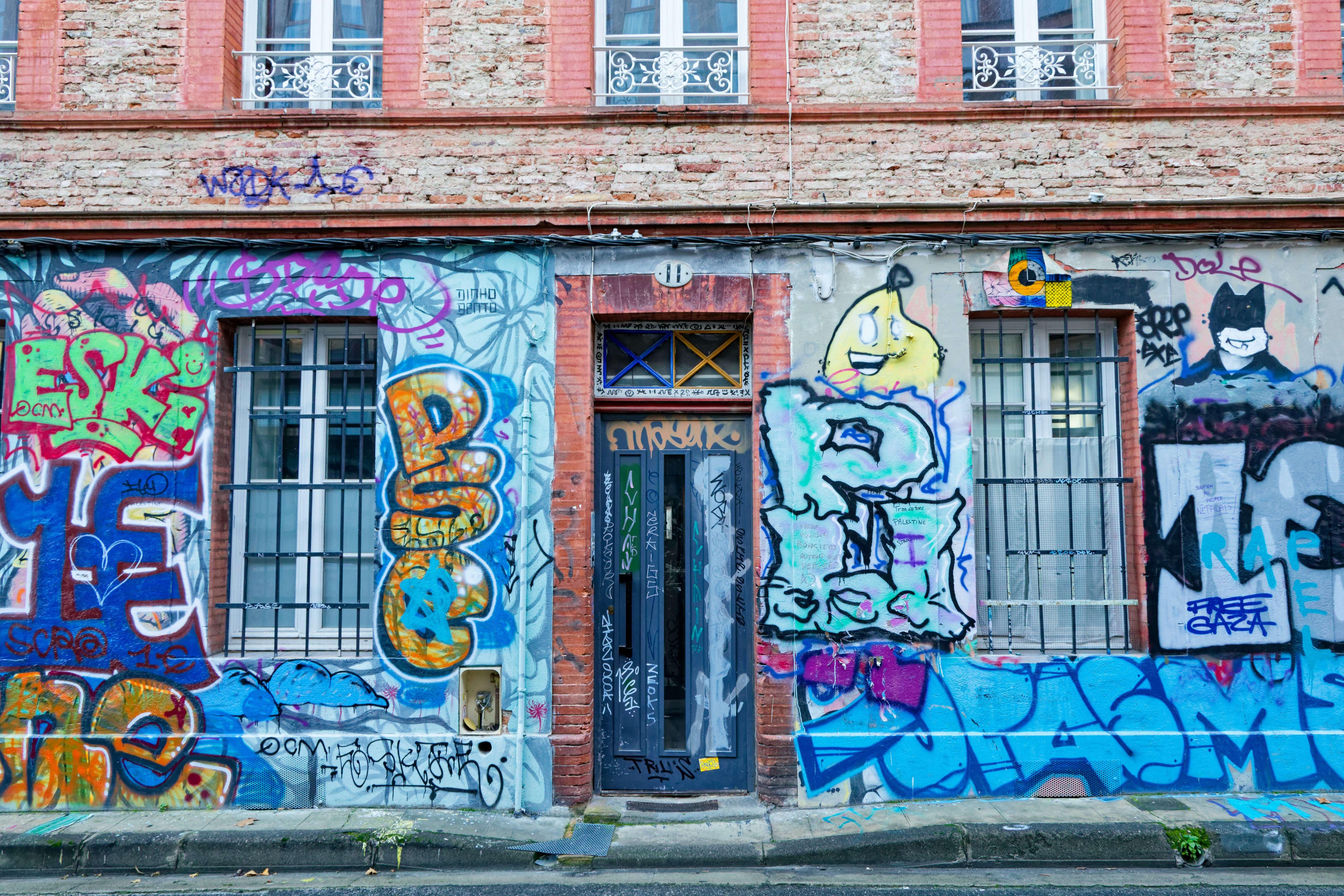 Graffiti-Filled Facade: A Doorway Between Color and Concrete