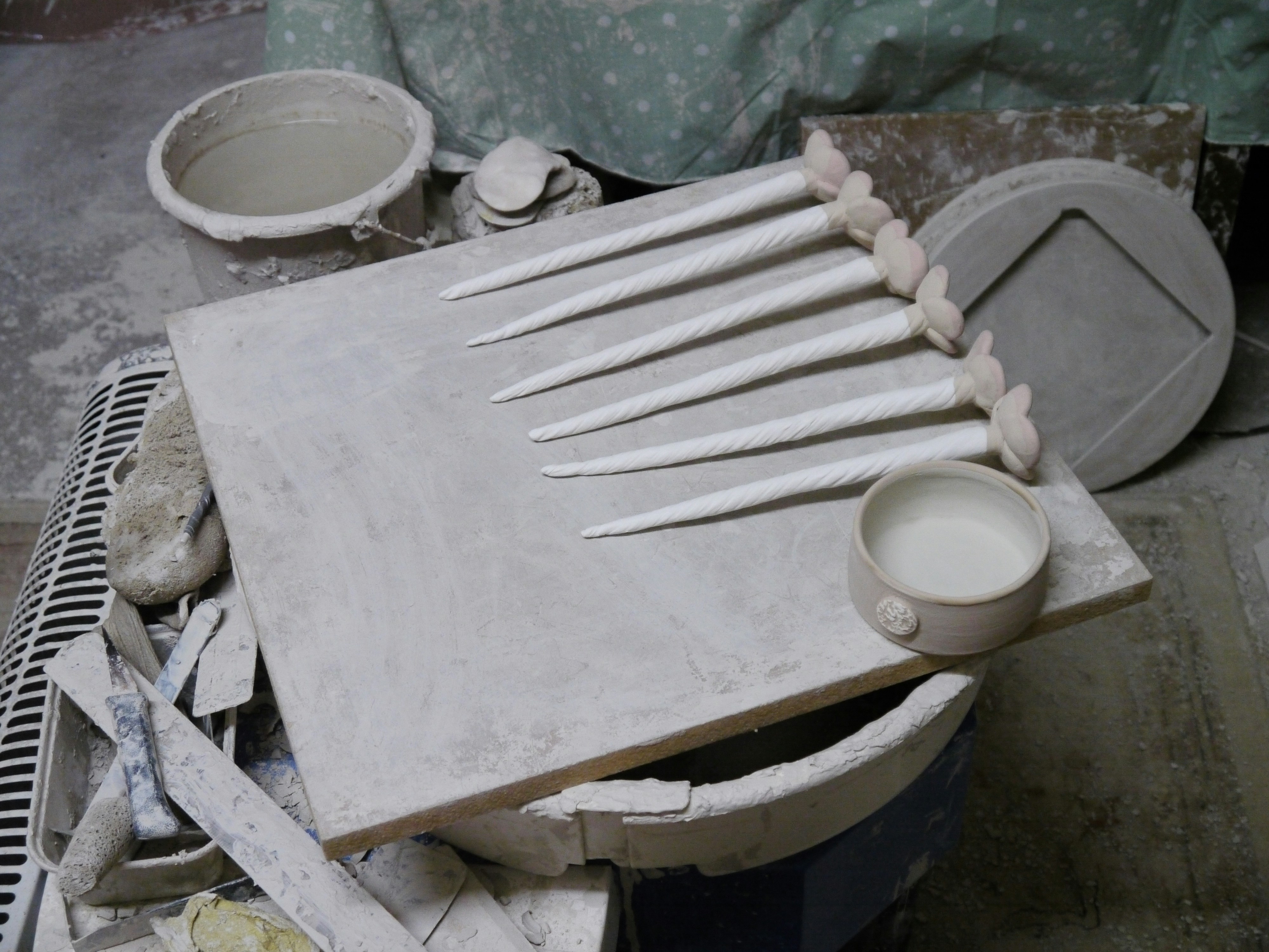 Scarred White Clay Studio: A Row of Needle-Shaped Tools Rest on a Slab