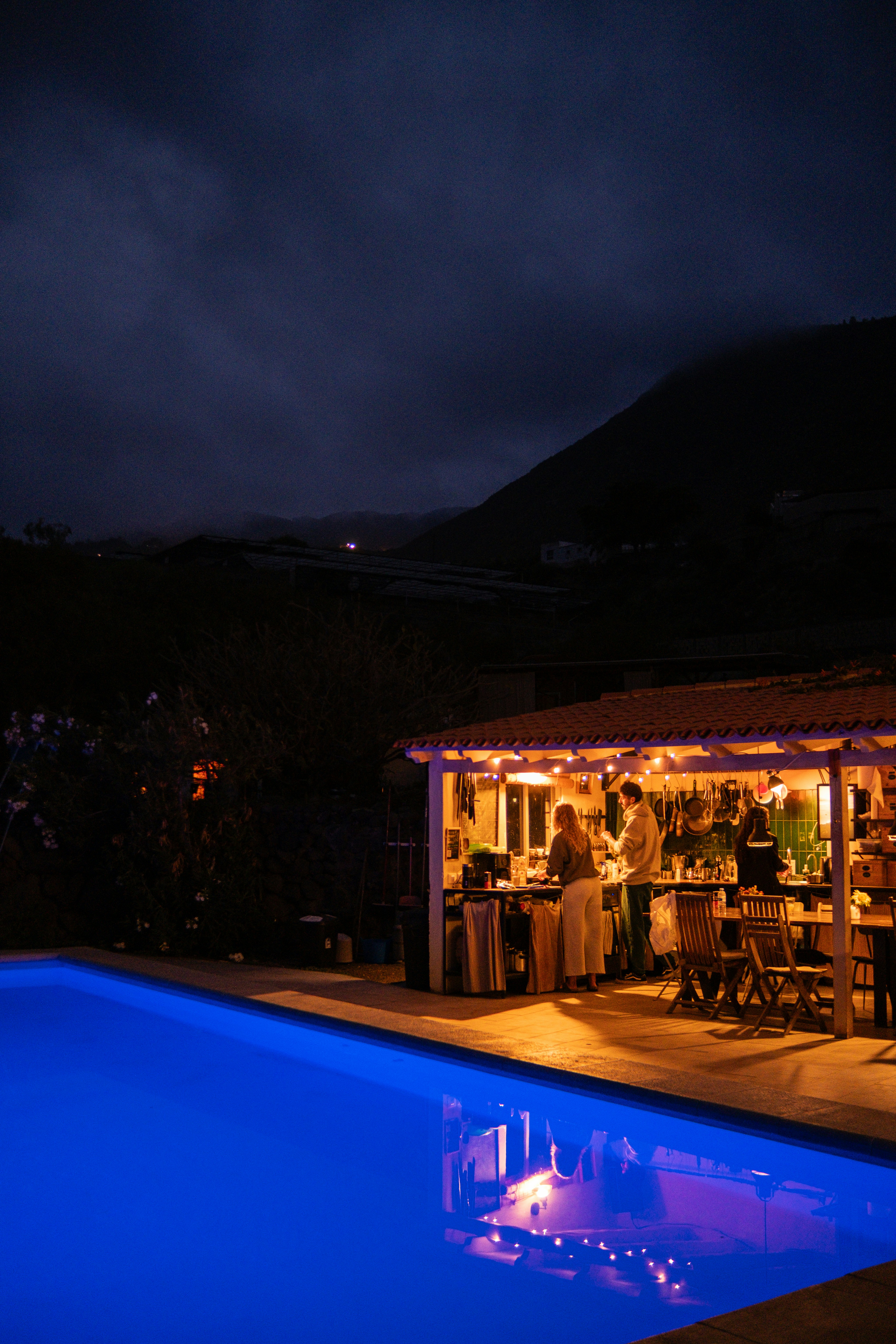 Evening Oasis: The Cozy Outdoor Kitchen by the Pool