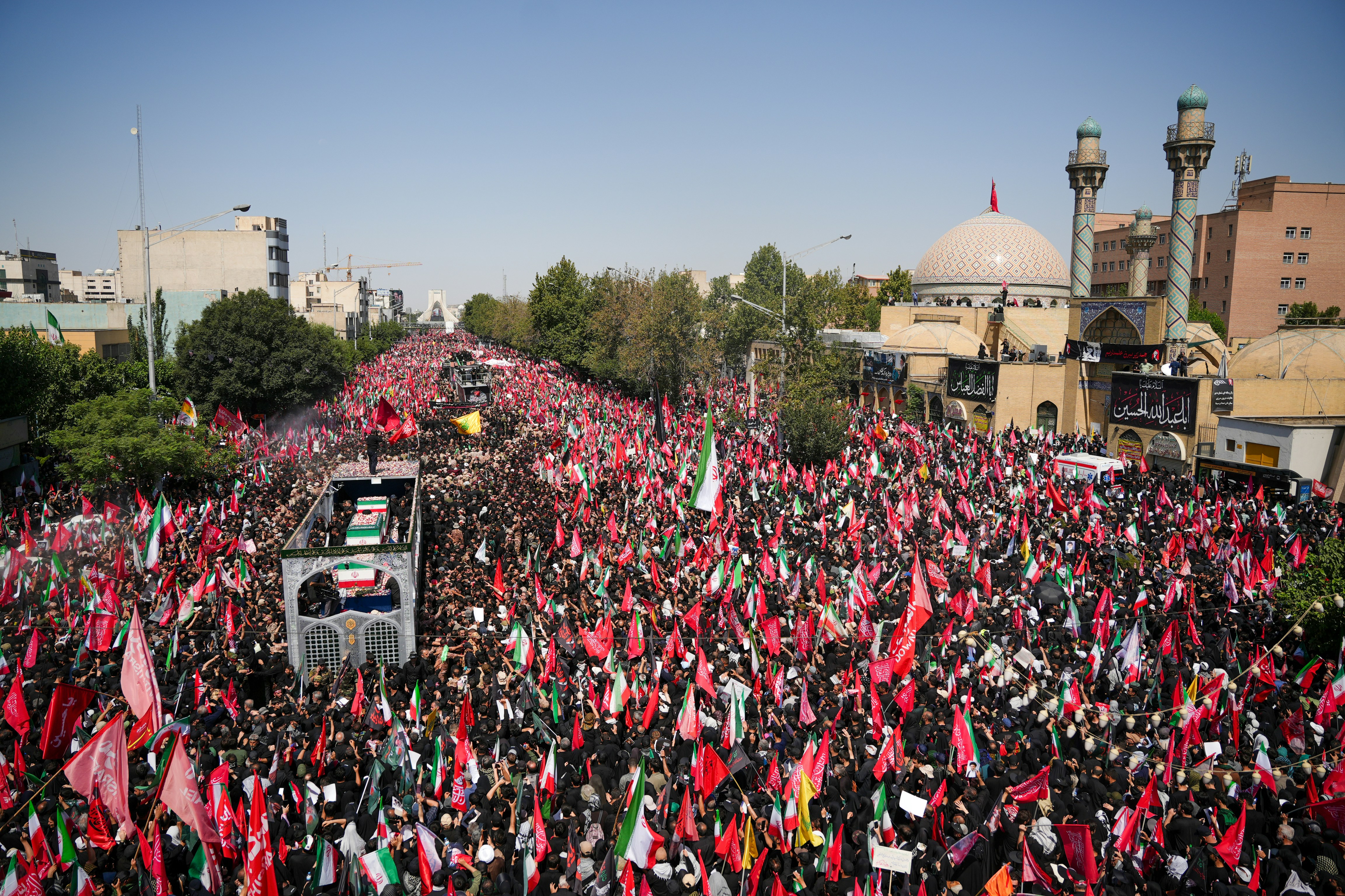 A Sea of Red and Green: A City Square Rally Under Clear Sky