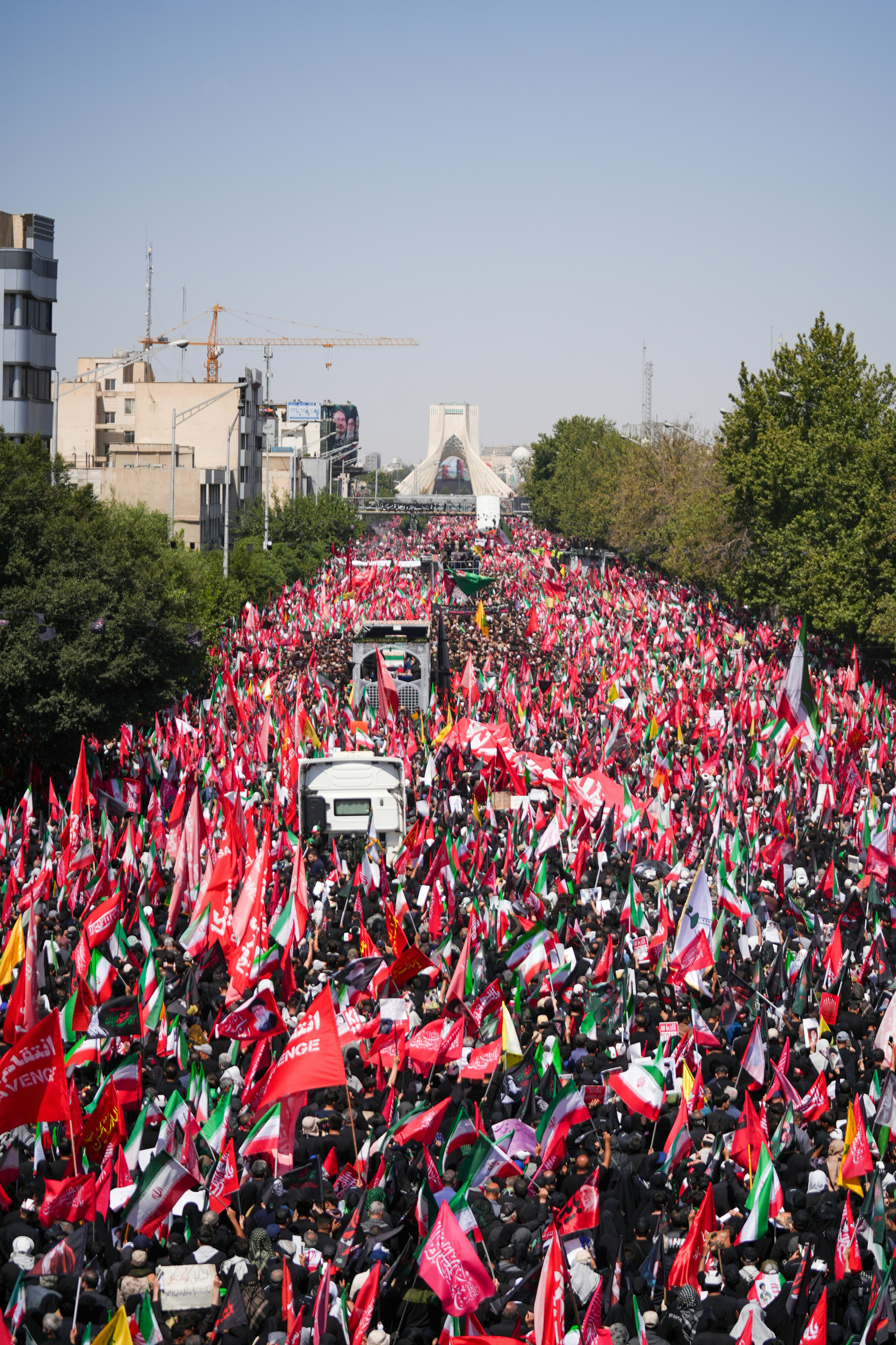 Marching Wave: A Sea of Flags Fortifies an Urban Avenue