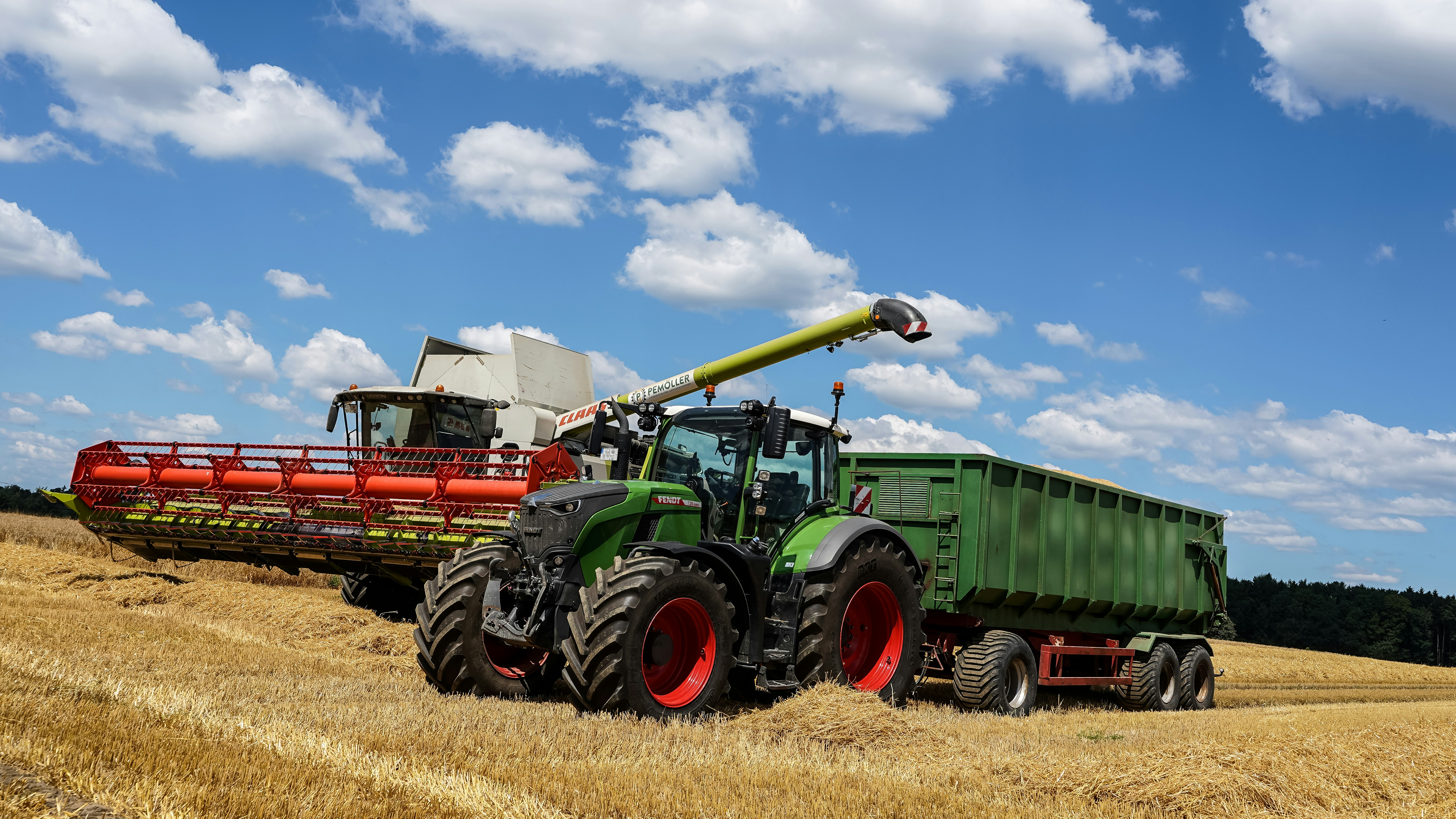 Harvest Duo: Green Tractor at the Edge of the Golden Field