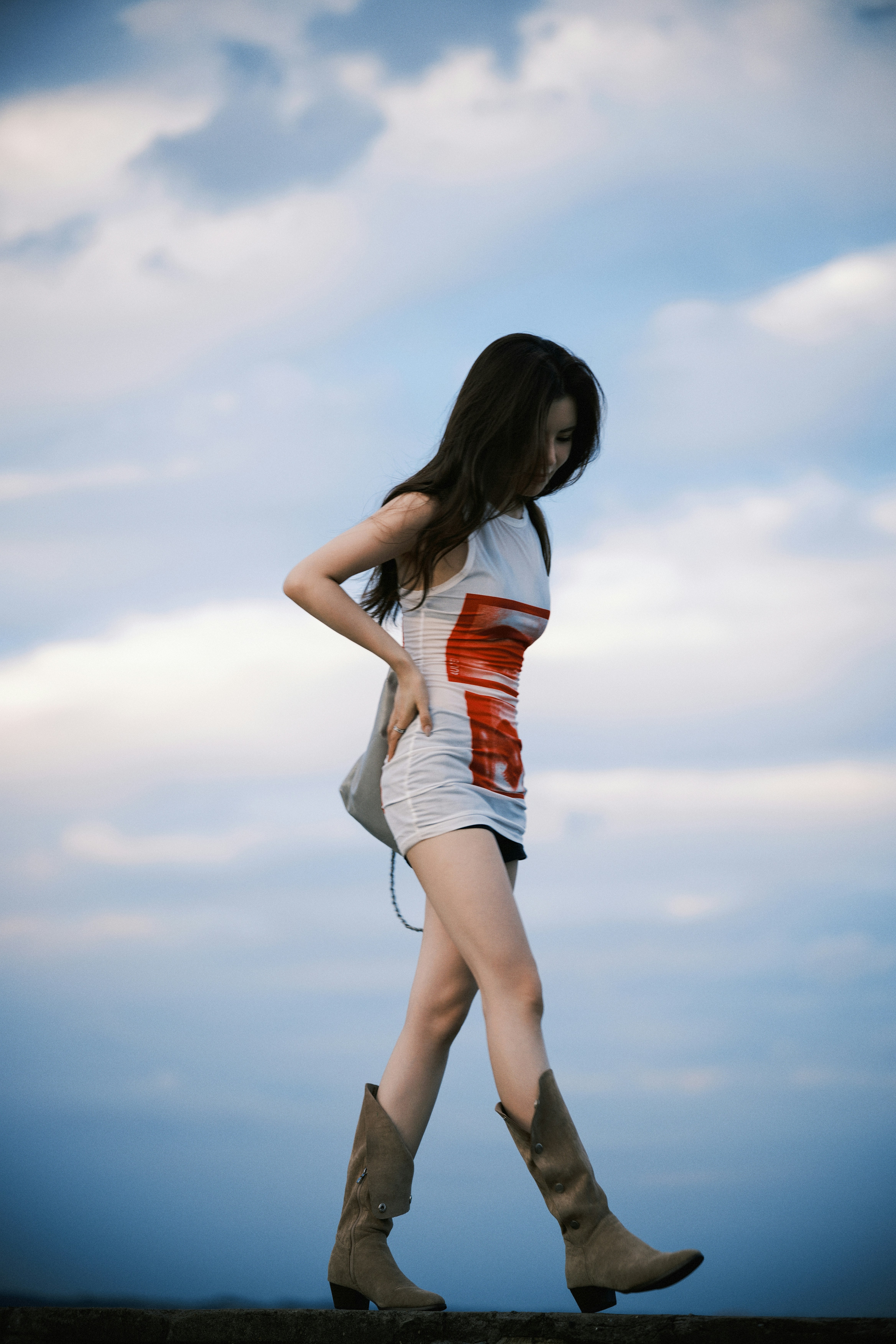 Stride in the Dusk: A Figure Walks Along the Edge of Sky