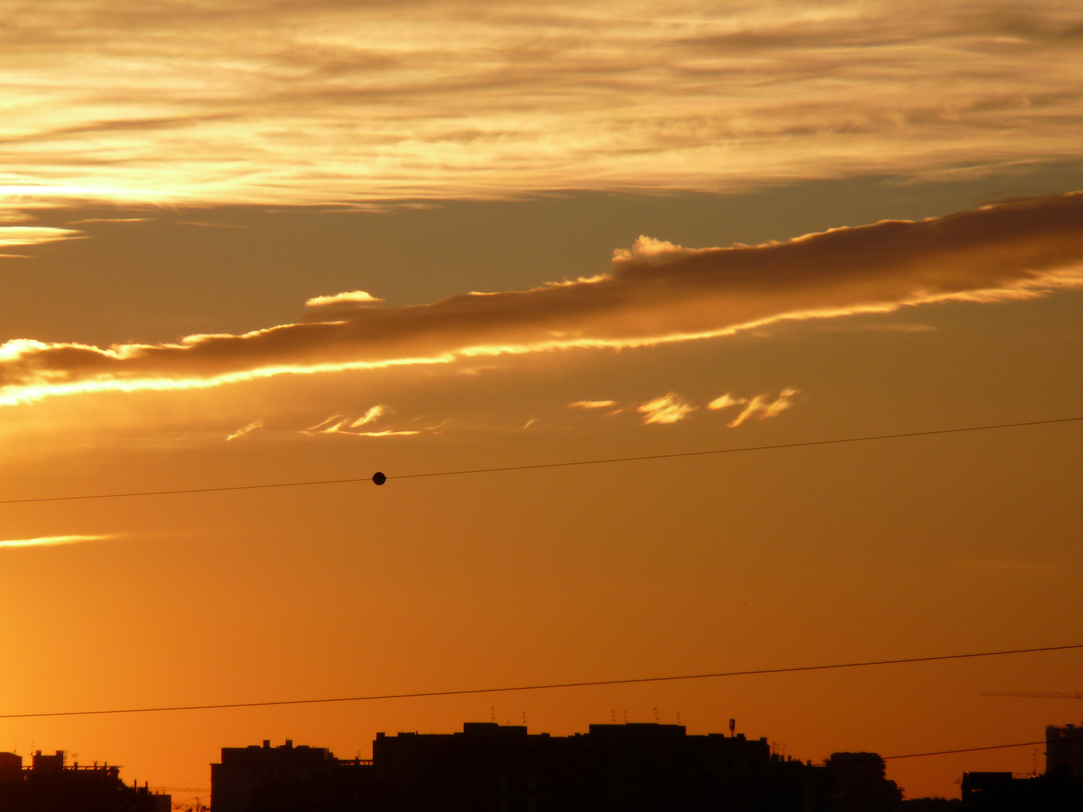 Low Horizon, High Sky: Sunset Over Distant Rooftops