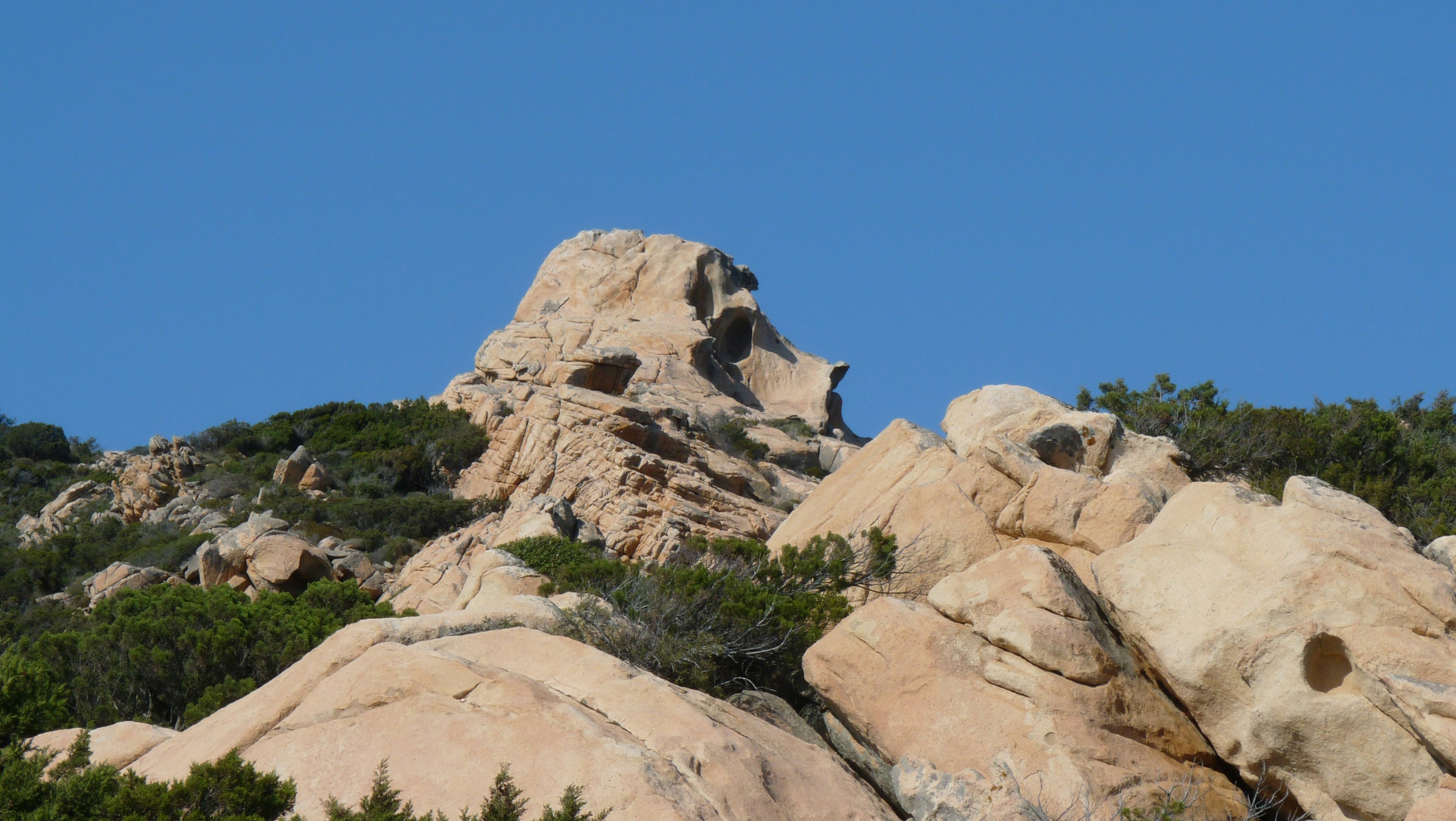 Sunlit Granite Peak Rising Above Coastal Molières