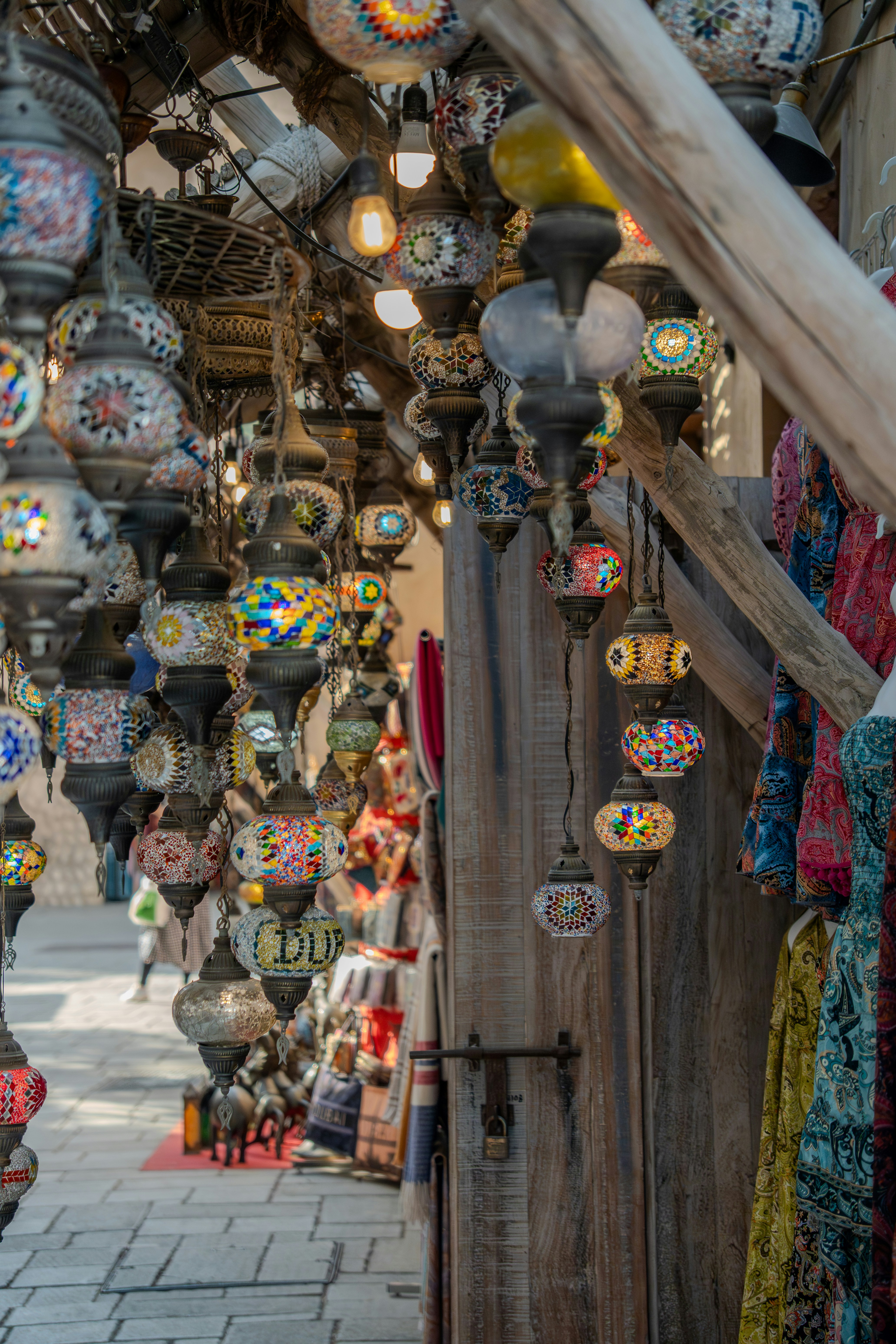 Lanterns in a narrow bazaar: a tapestry of colorful tea lamps