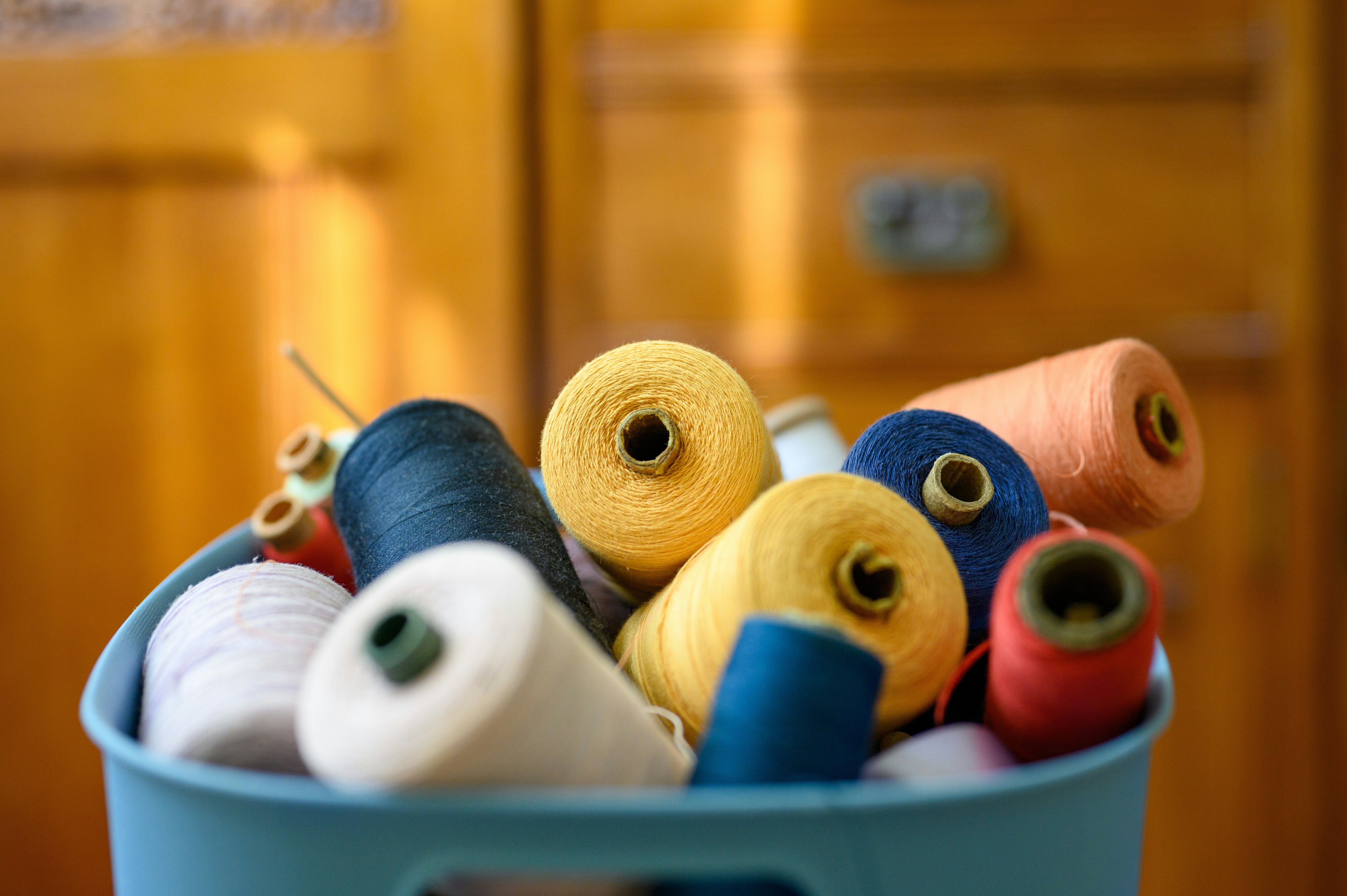 Threads of Color: A Basket of Spools in Bright Focus
