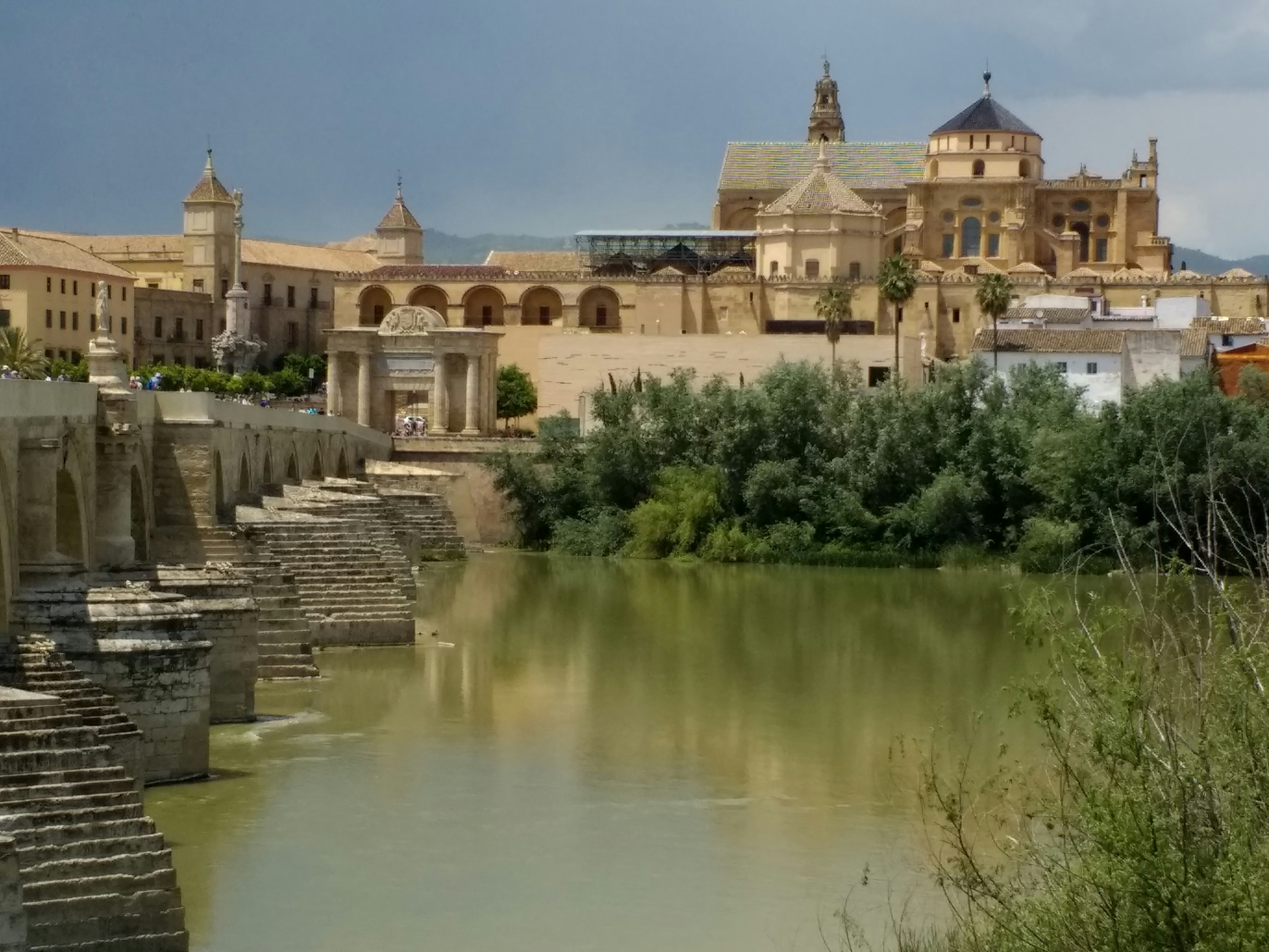 Riverside Fortress: A Muddy Channel Between Historic Stones