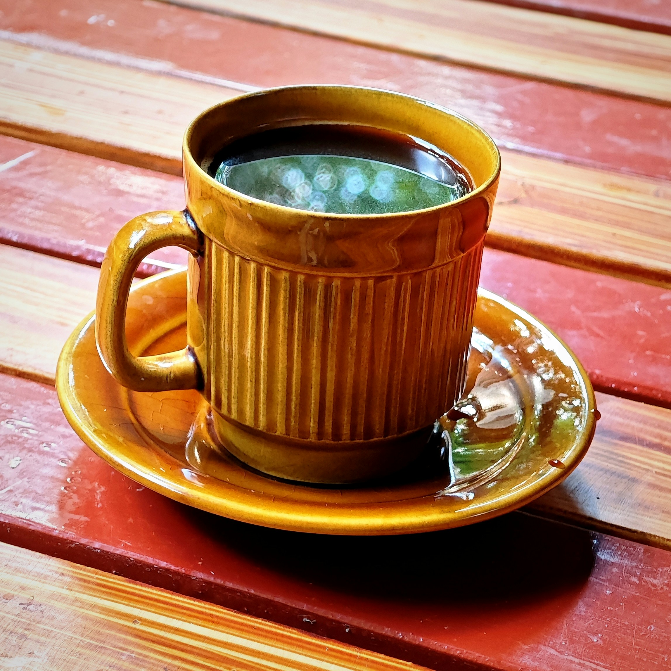 Glazed Cup on a Rivulet of Wooden Burnish