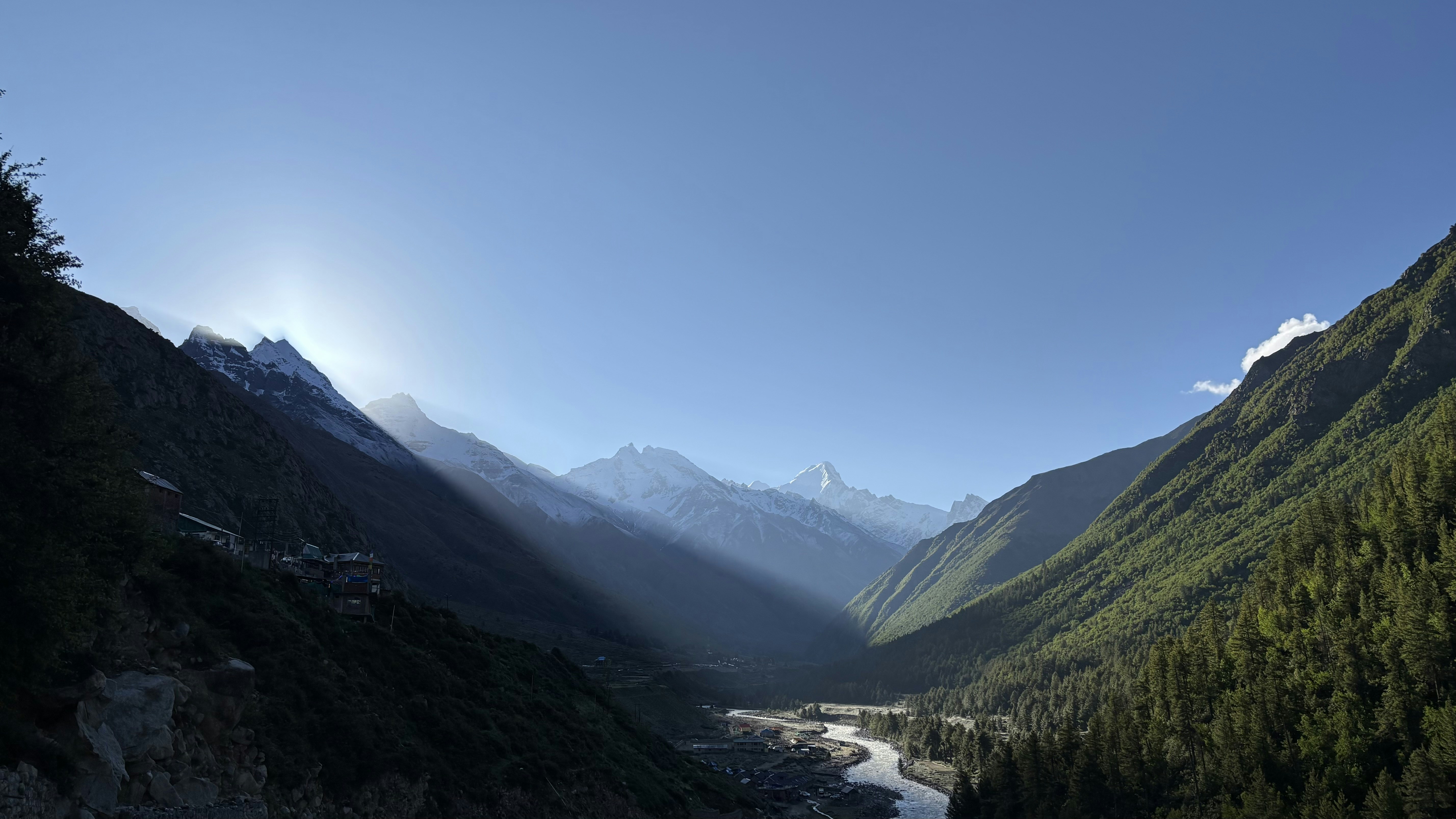 Sunlit Valley Between Standing Peaks