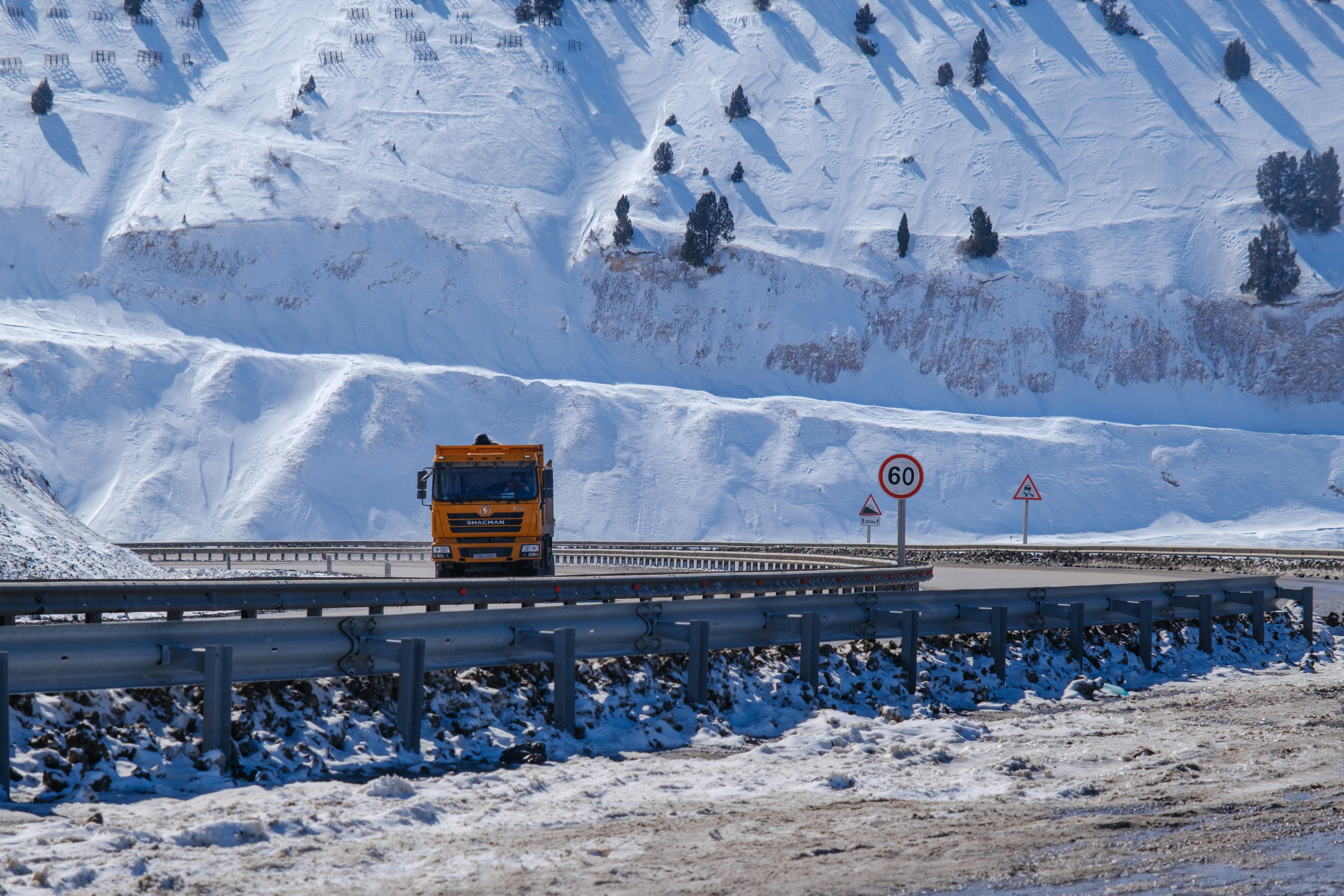 Orange Truck on a Snow-Covered Highway