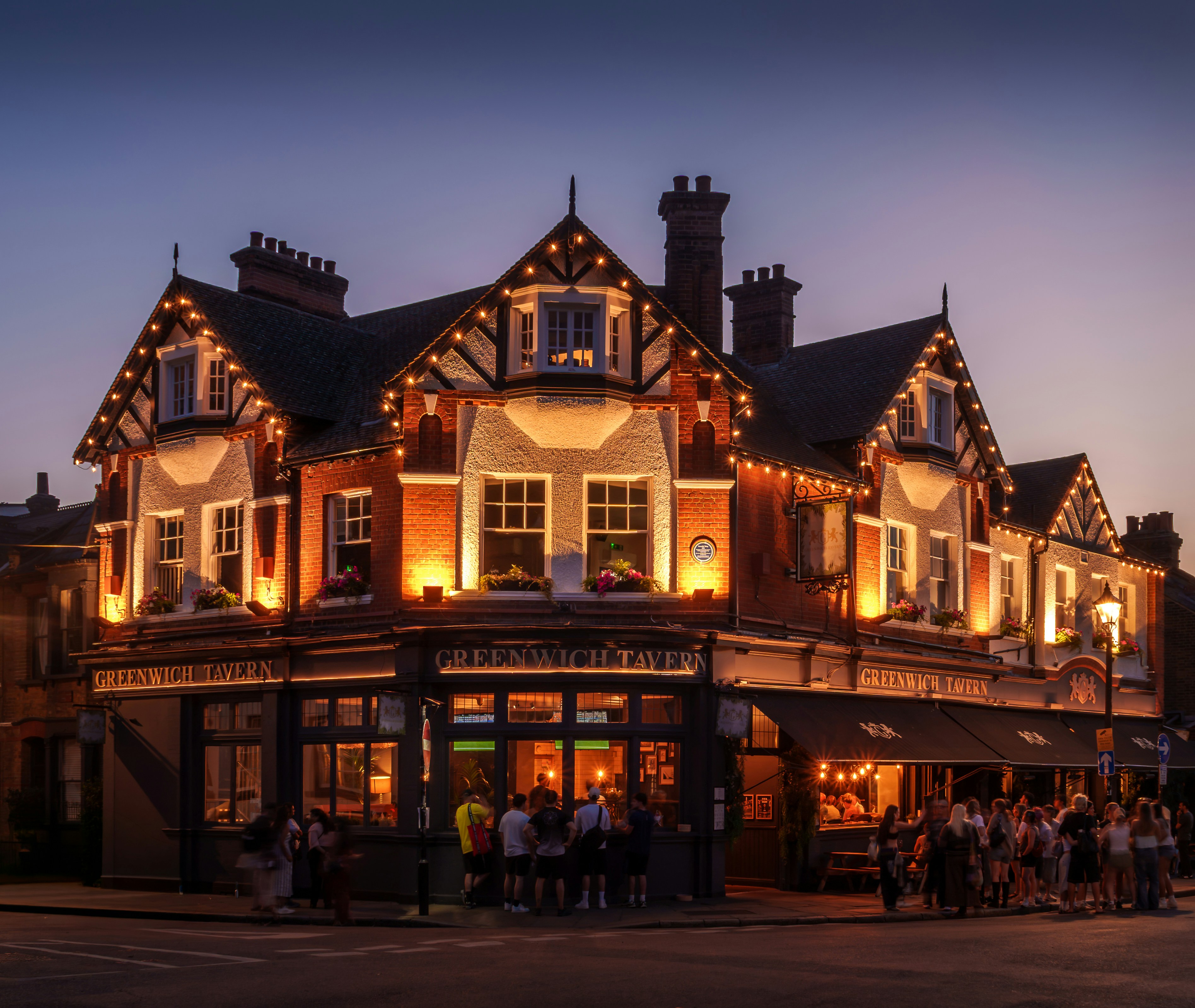 Glowing Tudor Facade: Evening at the Greenwitch Tavern