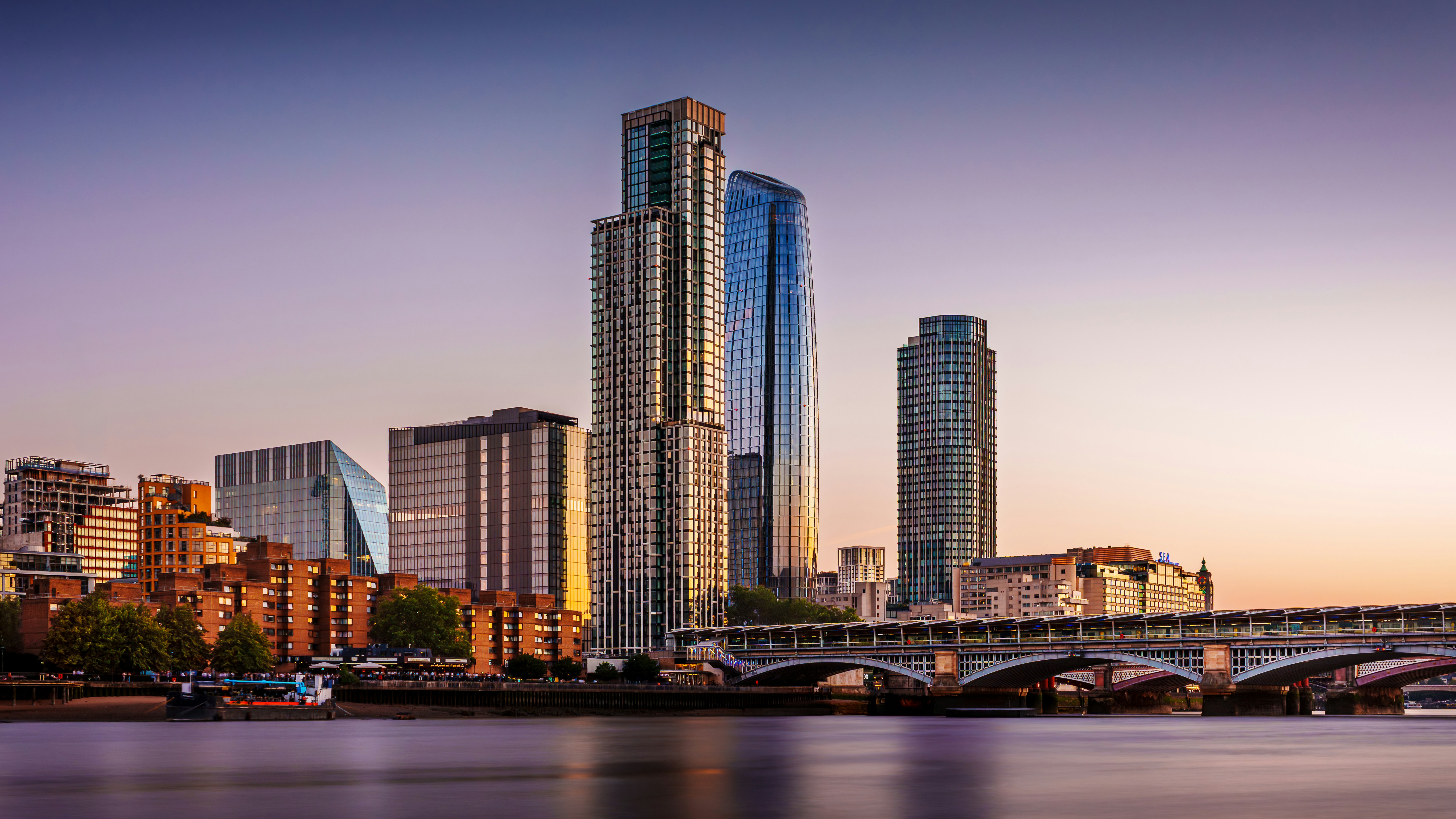 Sunset Over the Riverfront: Modern Towers Rise Above the Calm Water