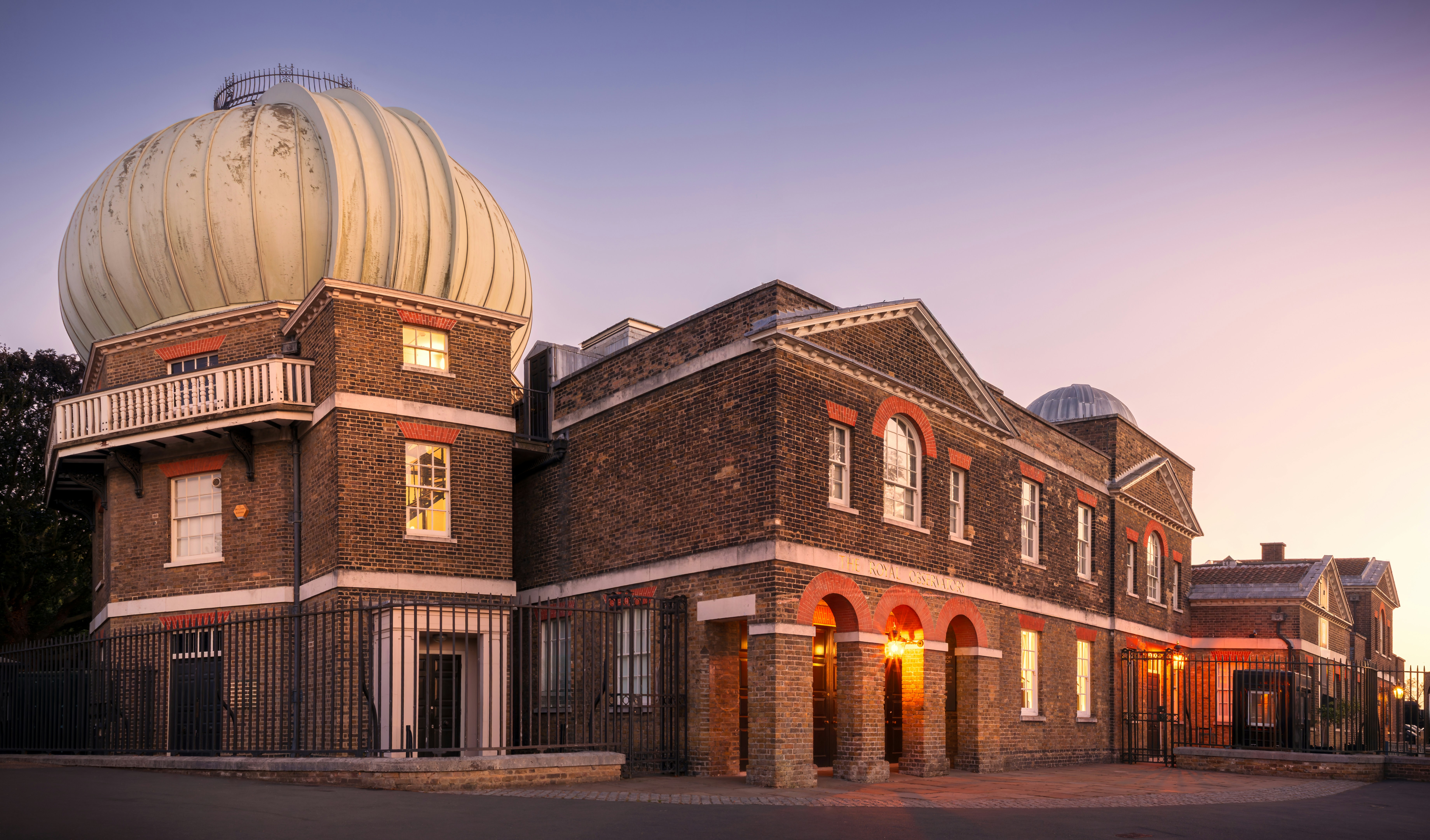 Gasometer at Dusk: Brick Facades and a Round Observatory Domed Roof