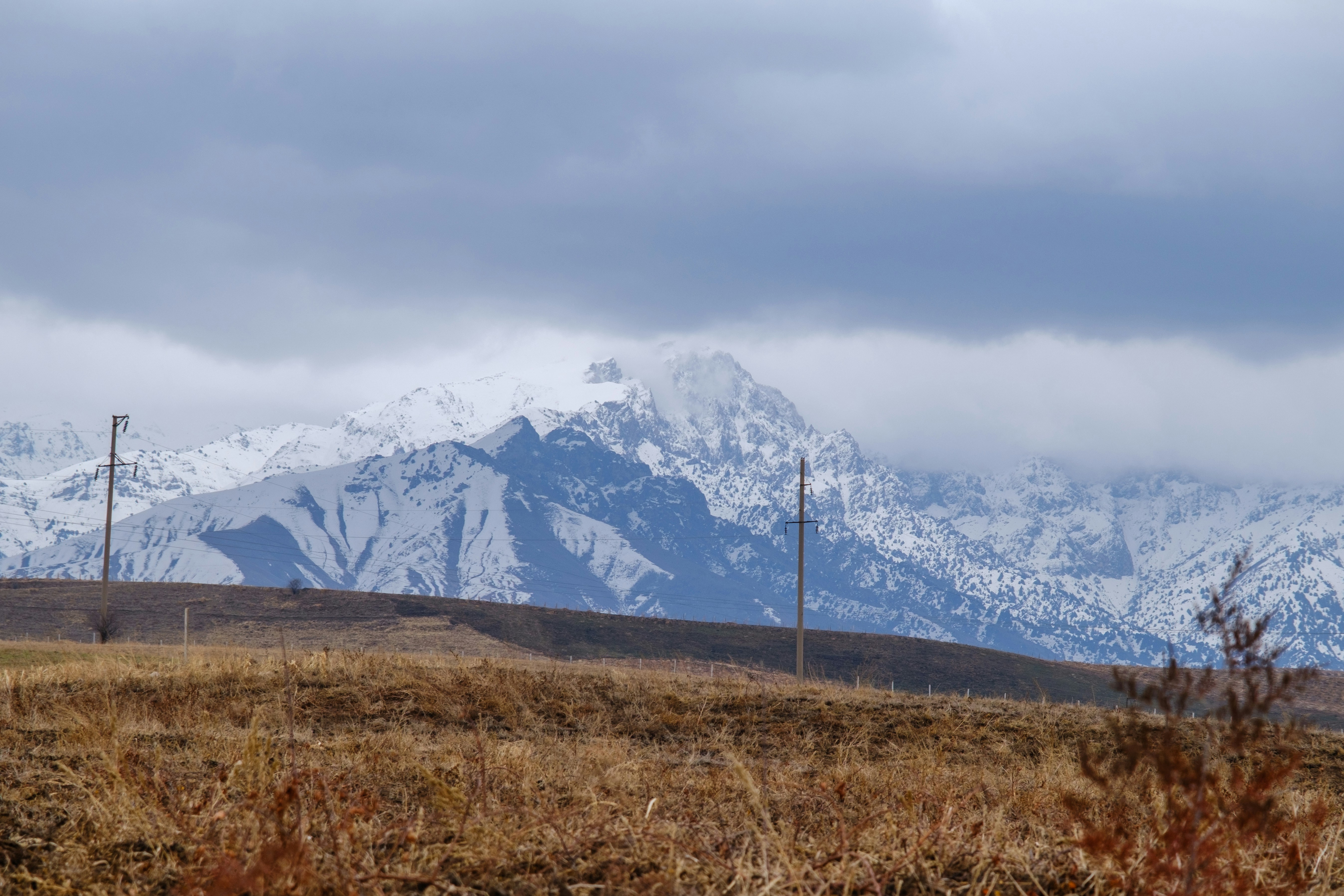 Snow-Capped Ridge Under Cloudy Crest