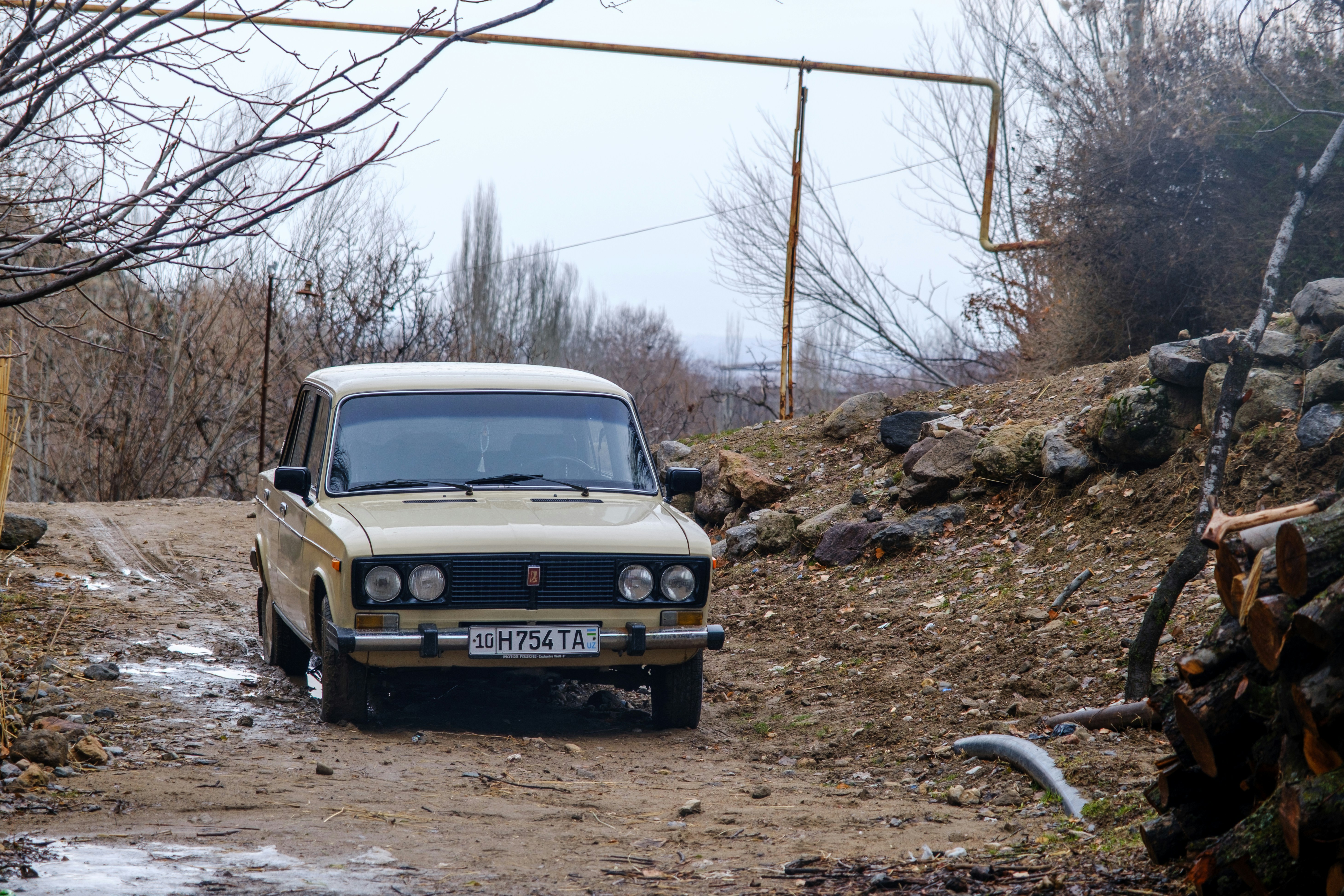 Dusty Rural Roadster: A Vintage Lada on a Rocky Descent