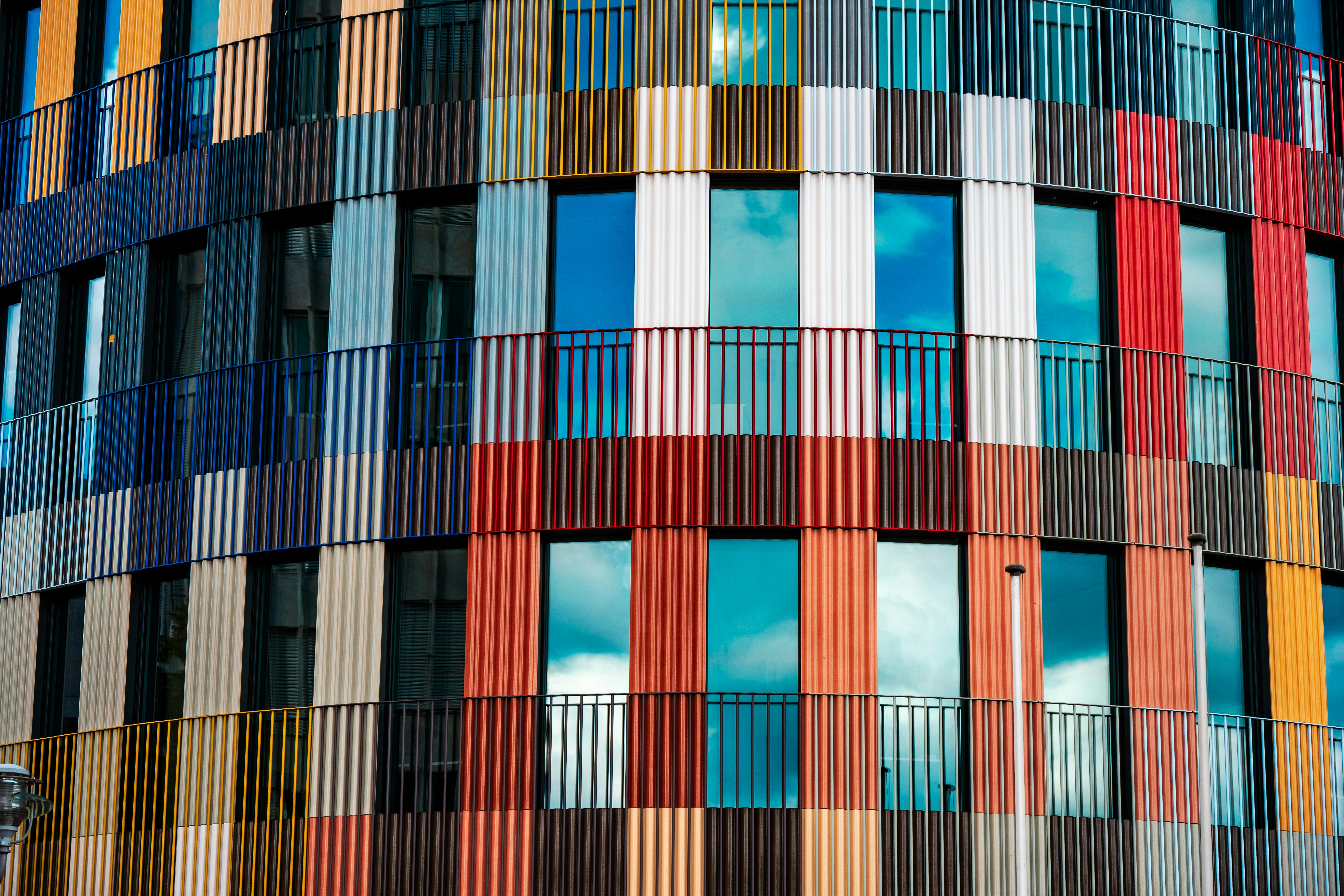 Chromatic Facade: A Dance of Vertical Stripes and Windows