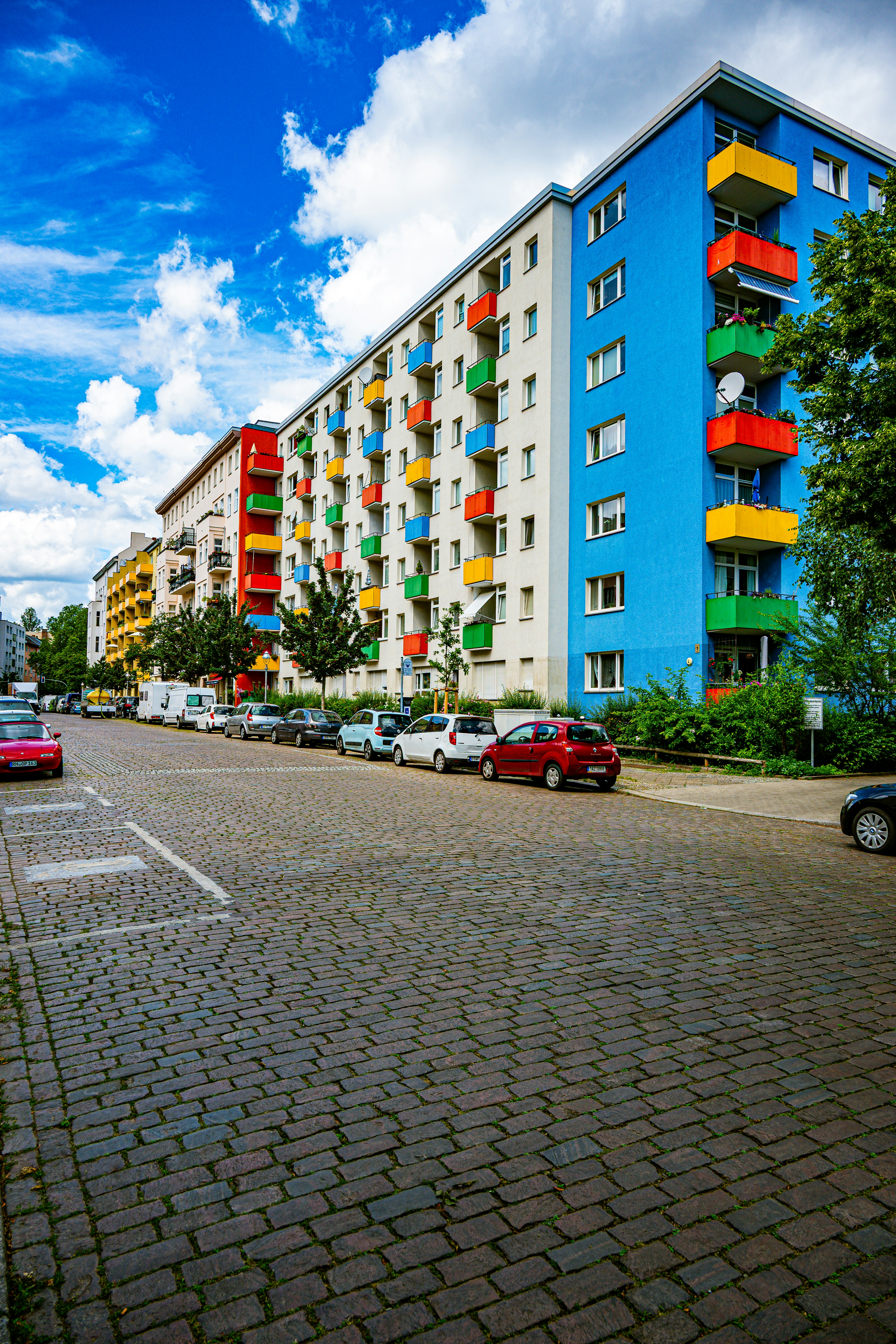 Colorful residential façade along a sunlit cobblestone street